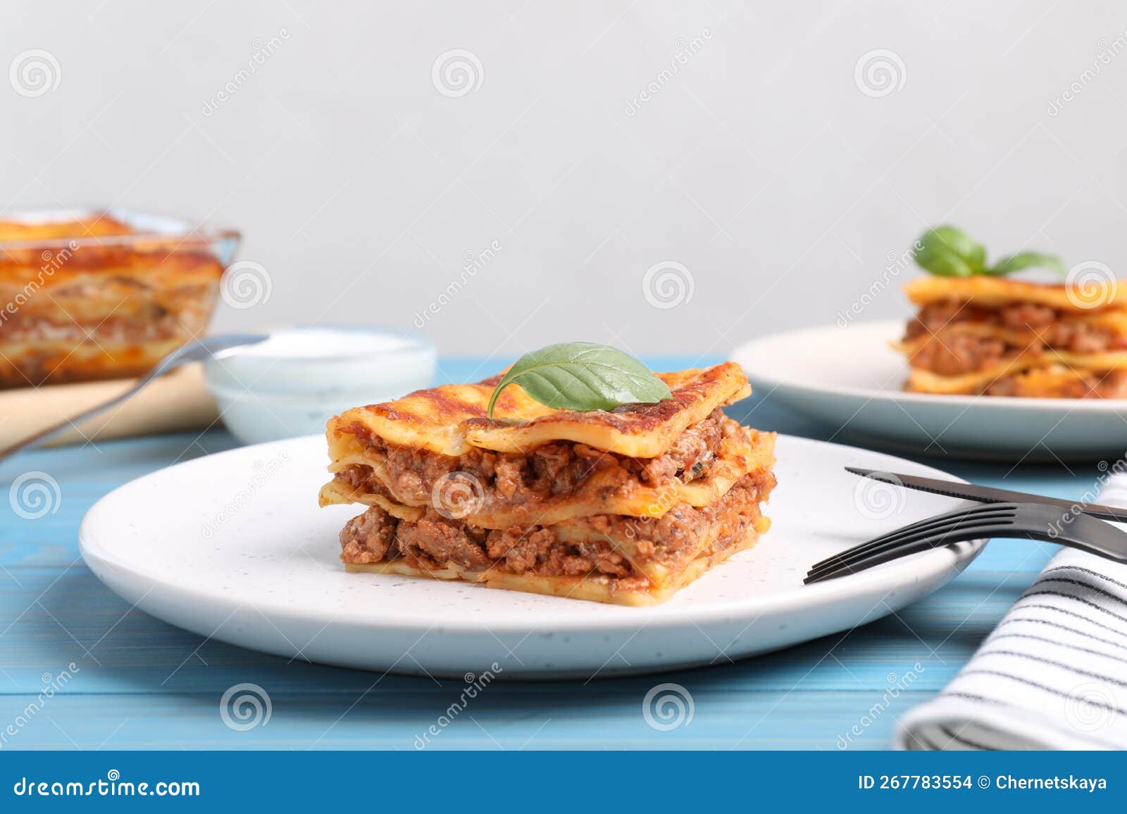 Tasty Cooked Lasagna Served on Light Blue Table Stock Photo - Image of ...