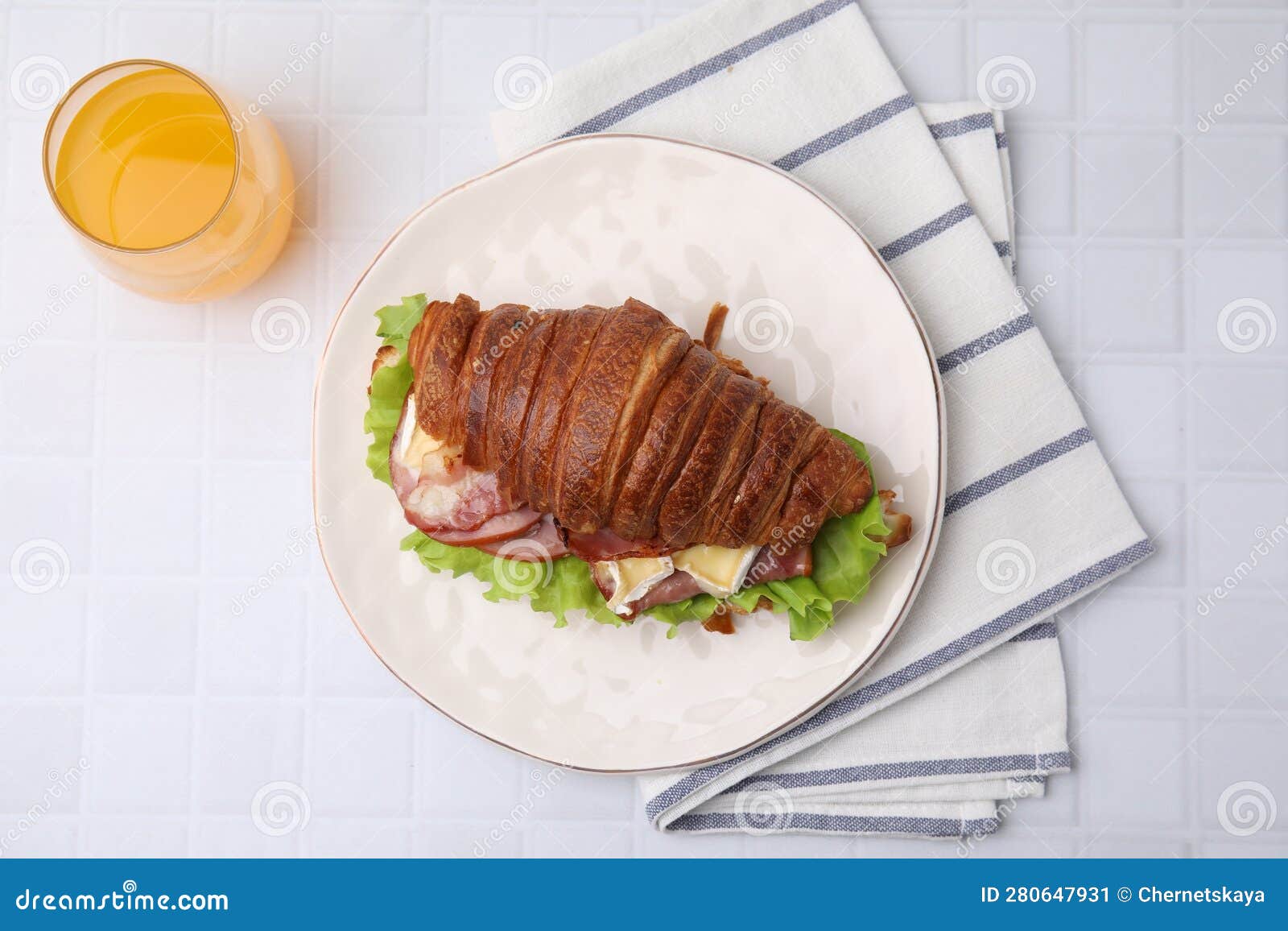 Tasty Croissant with Brie Cheese, Ham and Bacon on White Table, Flat ...