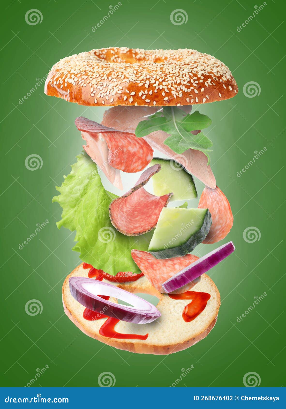 Tasty Cut Bagel with Different Ingredients Flying on Green Background ...