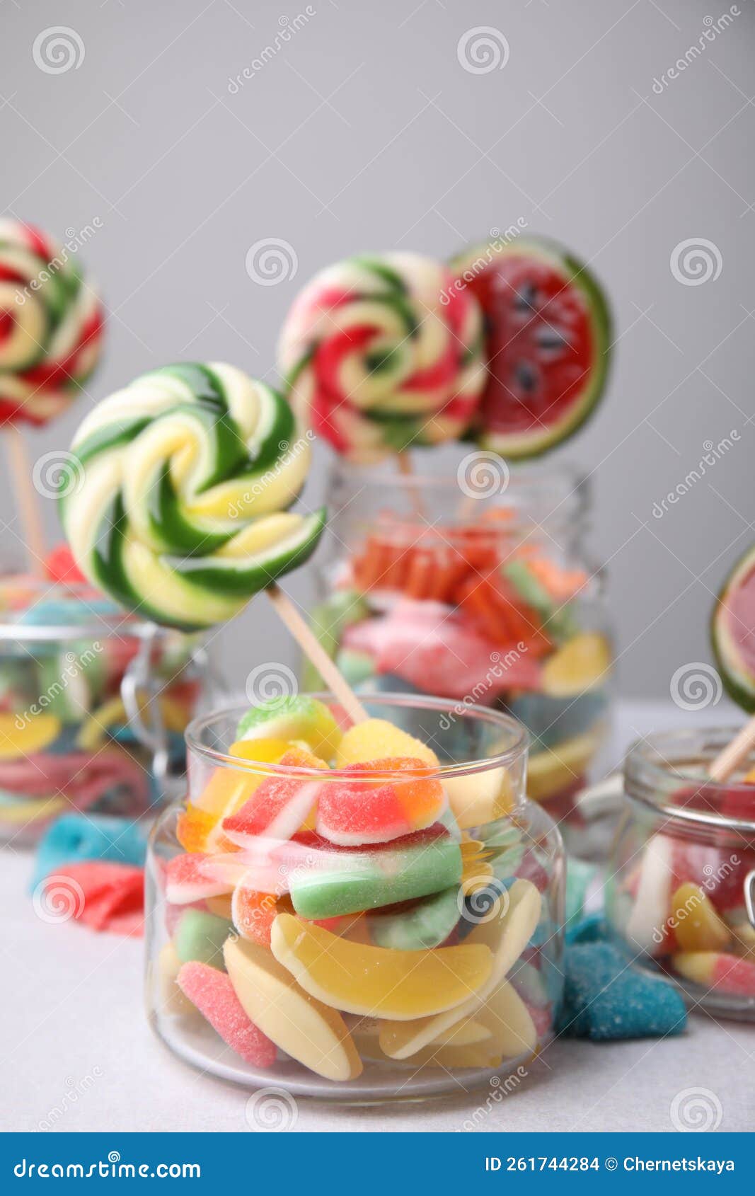 Tasty Different Candies in Jars on Light Grey Table Stock Photo - Image ...