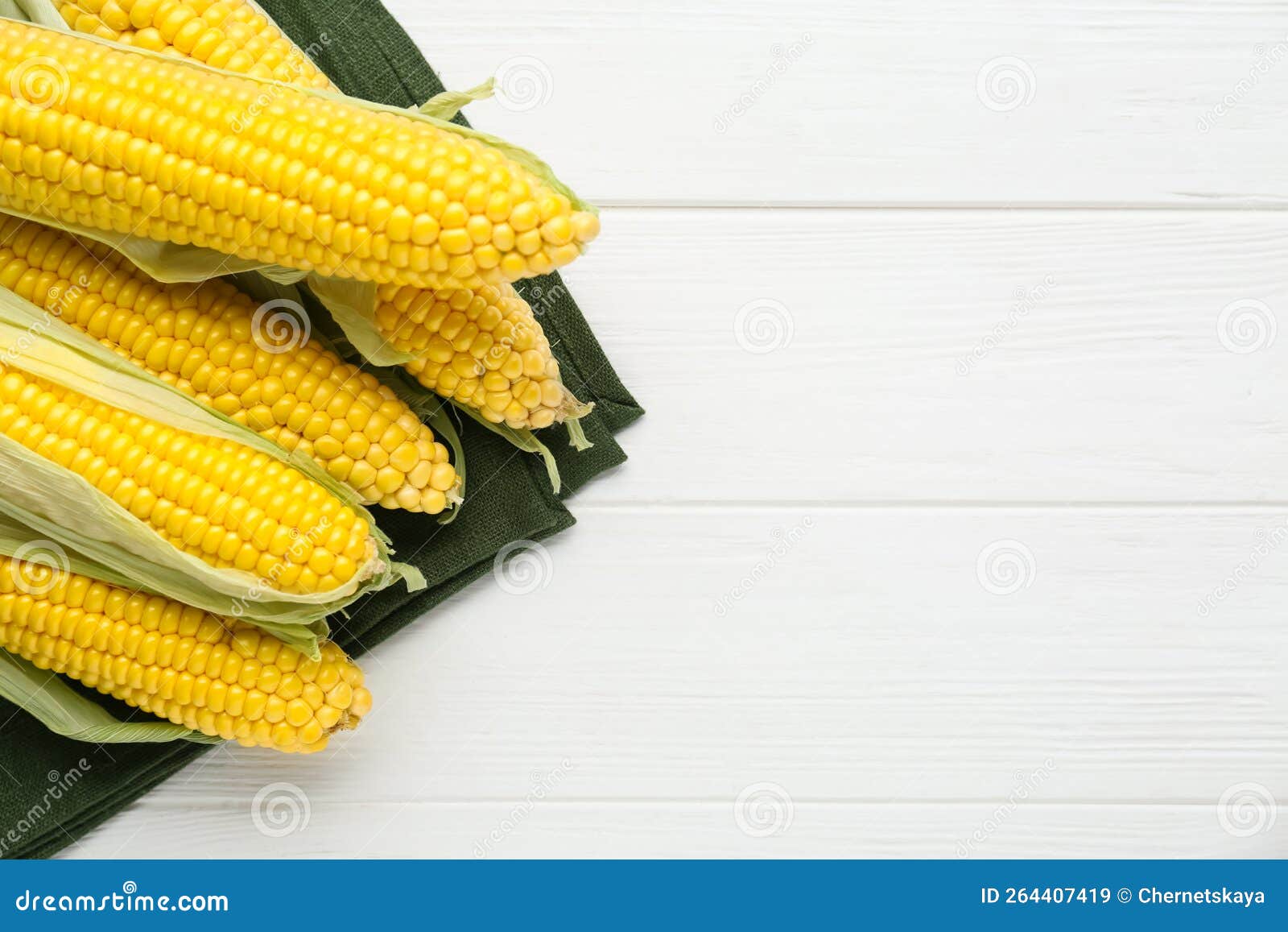Tasty Fresh Corn Cobs on White Wooden Table, Top View. Space for Text ...