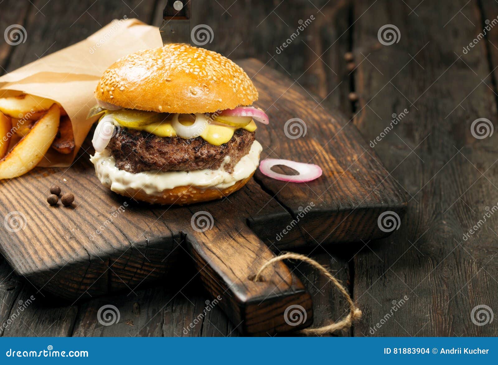 Tasty Grilled Beef Burger with Potatoes on a Dark Board Stock Photo ...
