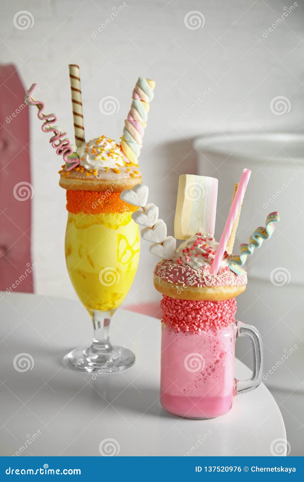 Tasty Milk Shakes with Sweets in Glassware on Table Stock Photo - Image ...