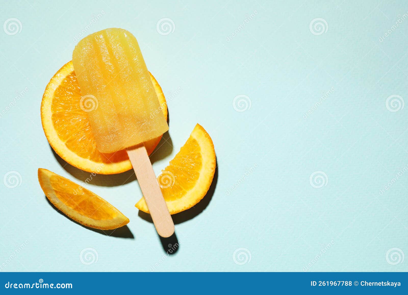 Tasty Orange Ice Pop and Space for Text on Pale Light Blue Background ...