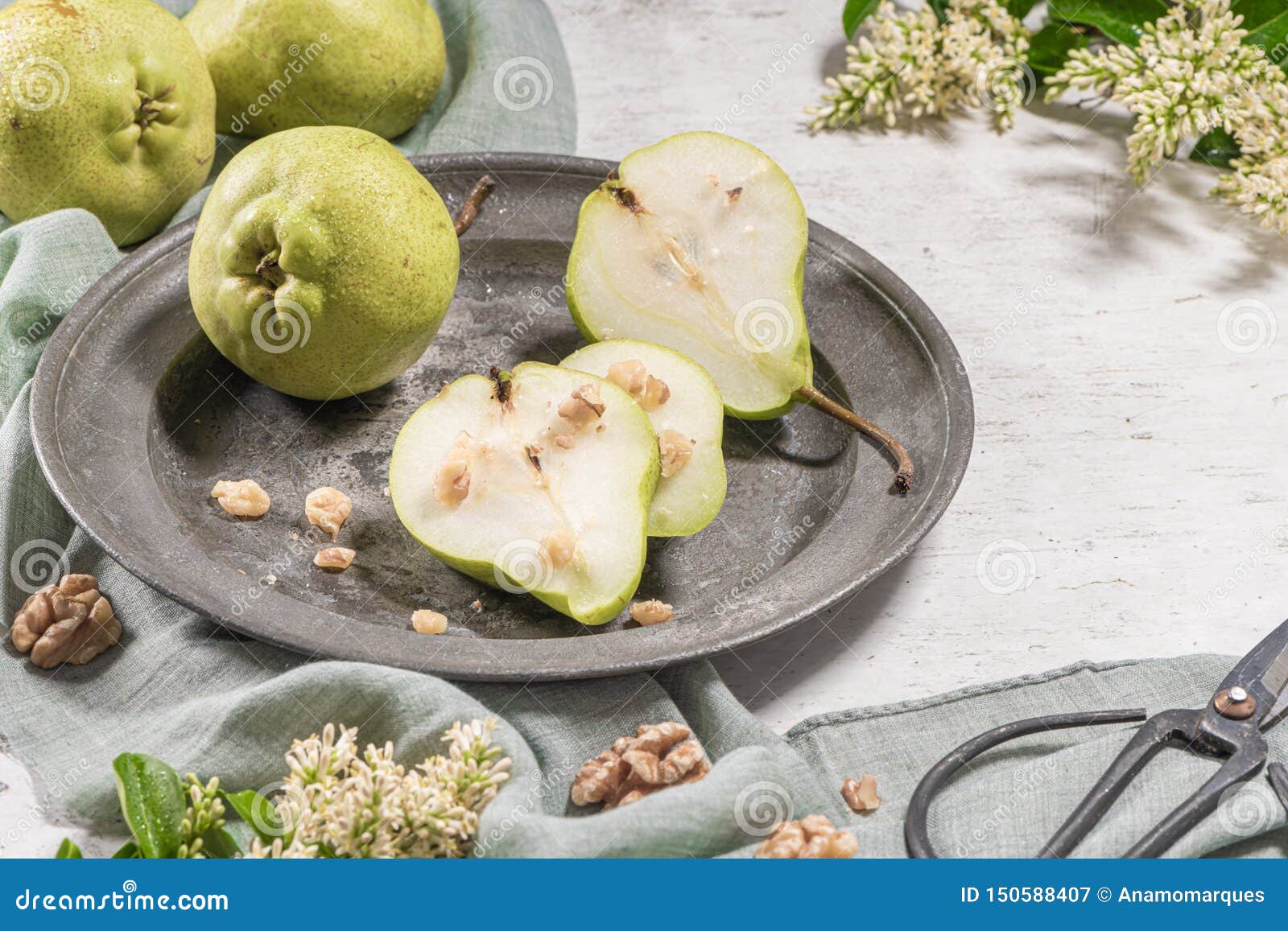 Tasty Pears with Nuts. a Table Decorated with Flowers and a Plate of ...