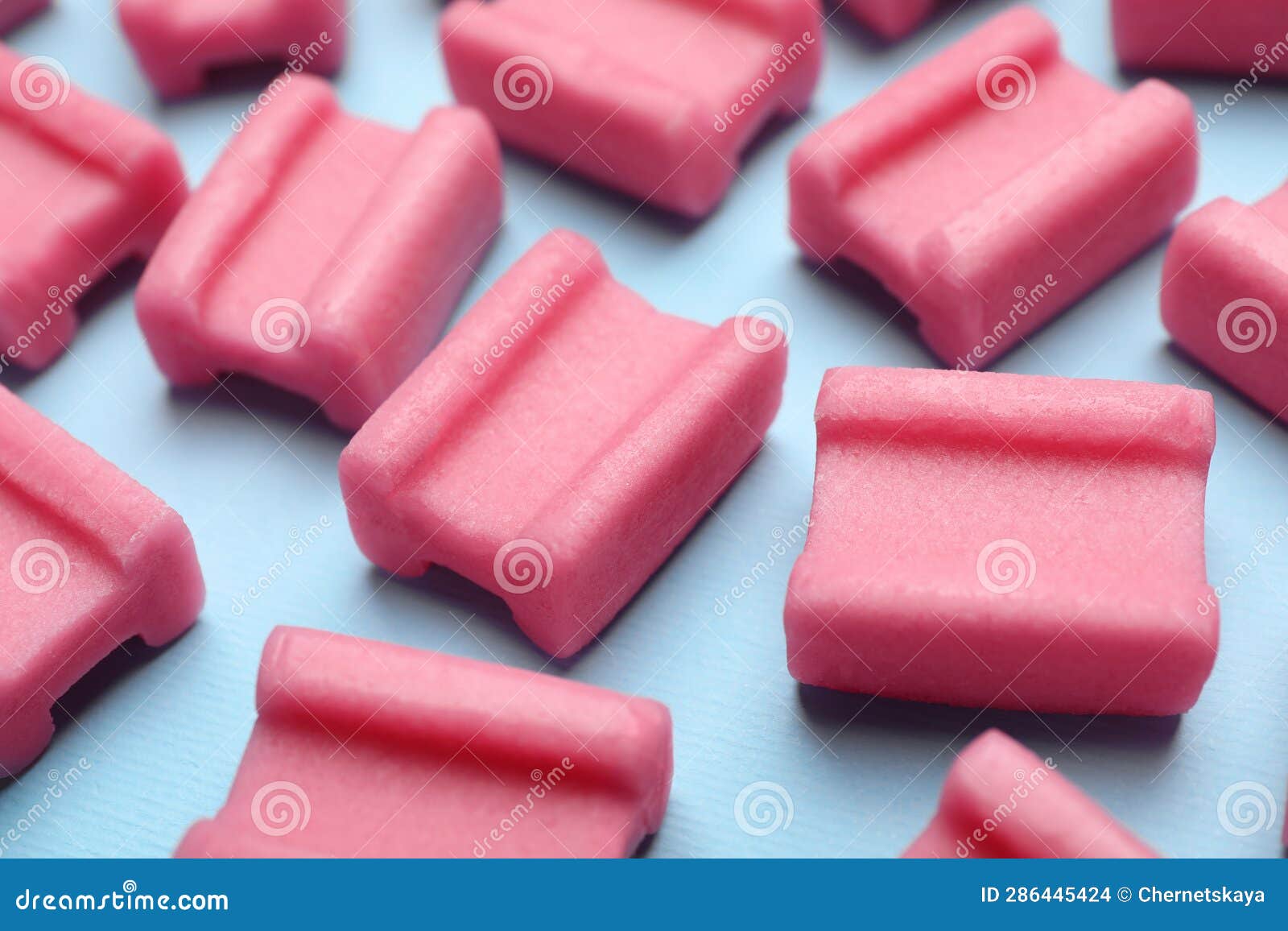 Tasty Pink Chewing Gums on Light Blue Background, Closeup Stock Photo ...