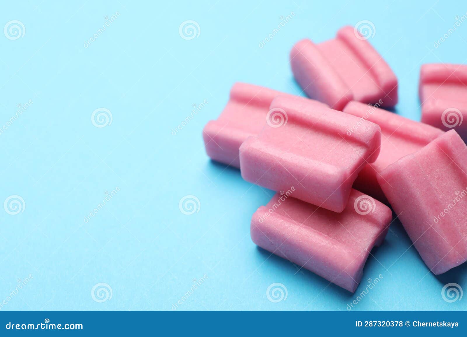 Tasty Pink Chewing Gums on Light Blue Background, Closeup. Space for ...