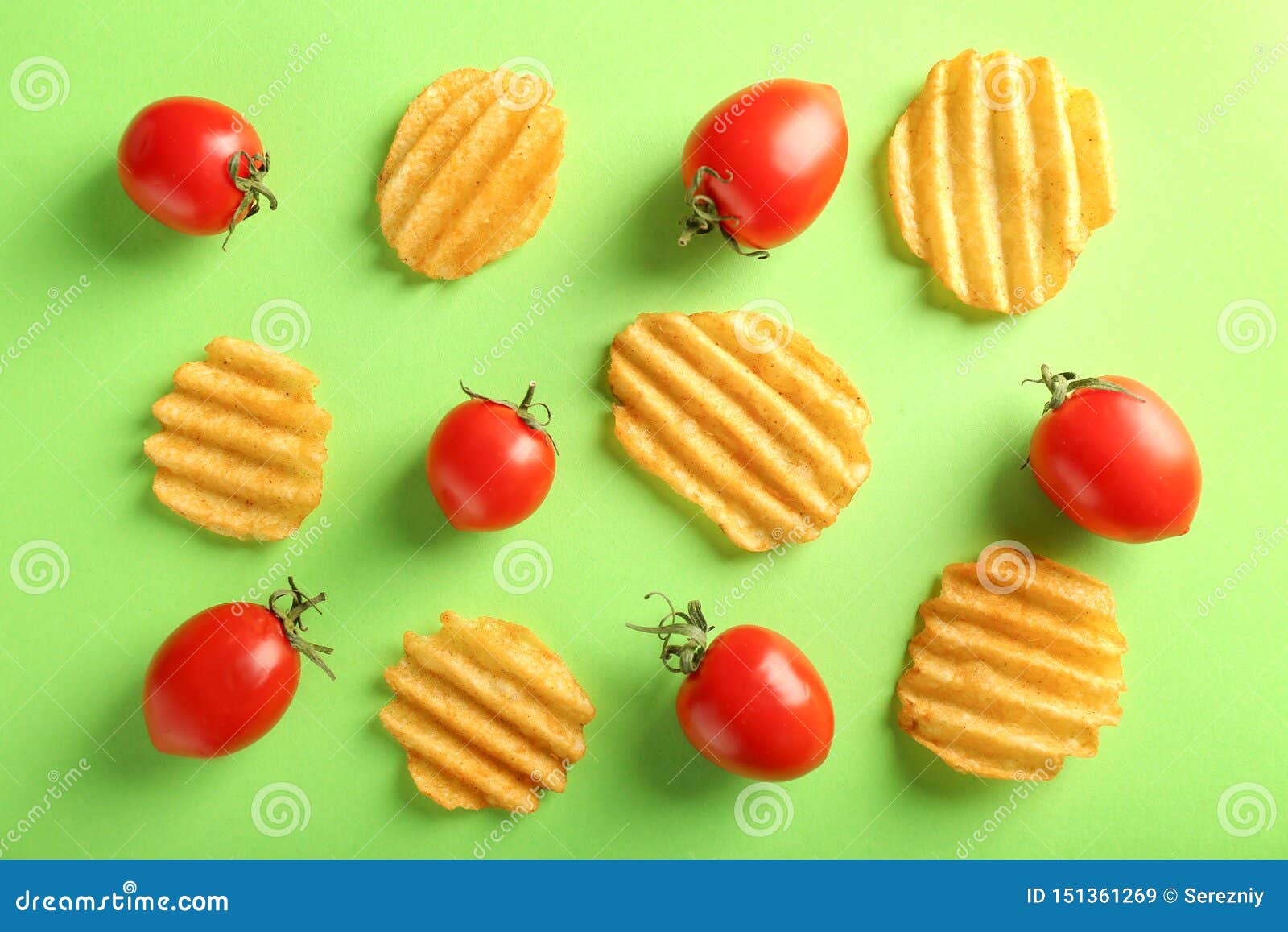 Tasty Potato Chips with Tomatoes on Color Background Stock Image ...