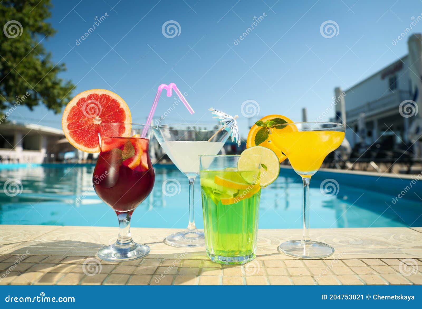 Tasty Refreshing Cocktails On Edge Of Swimming Pool Party Drinks Stock