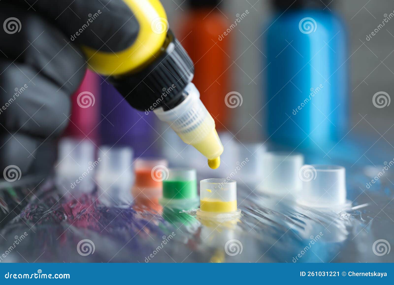 Tattoo Artist Dripping Yellow Tattoo Ink into Cap on Table, Closeup ...