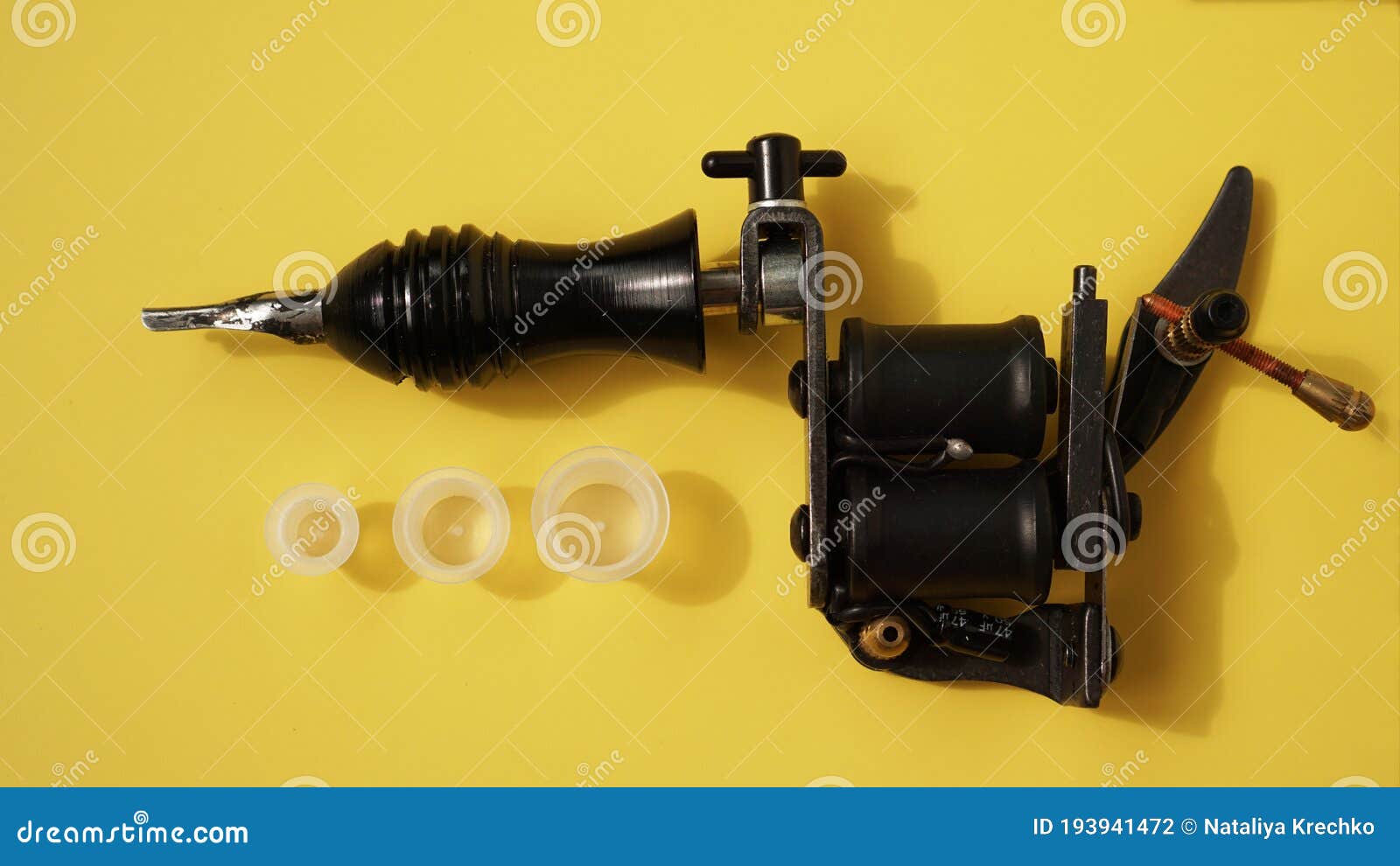 Tattoo Equipment, Tattoo Ink Plastic Caps and Tattoo Machine on Yellow ...