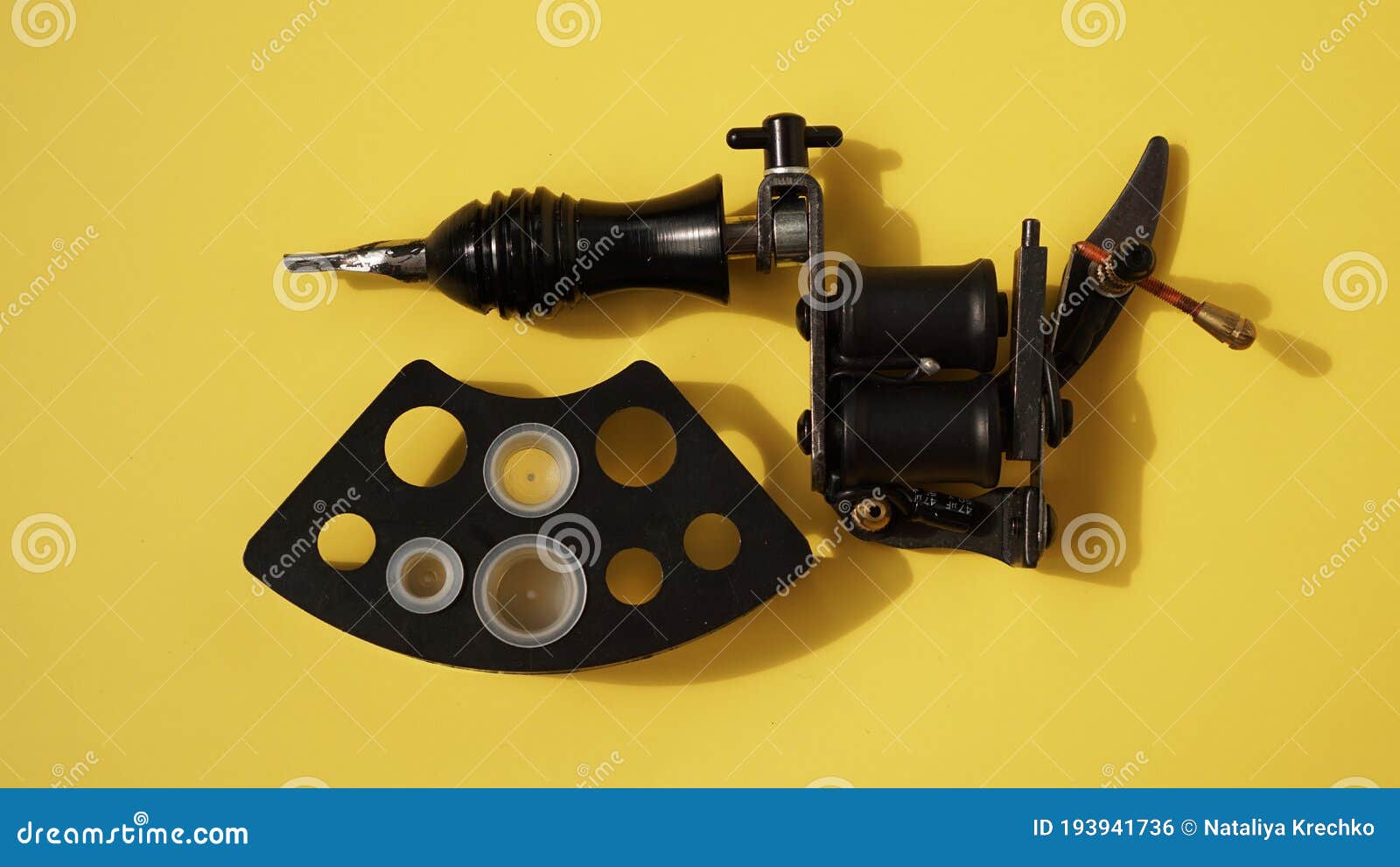 Tattoo Equipment, Tattoo Ink Plastic Caps and Tattoo Machine on Yellow ...