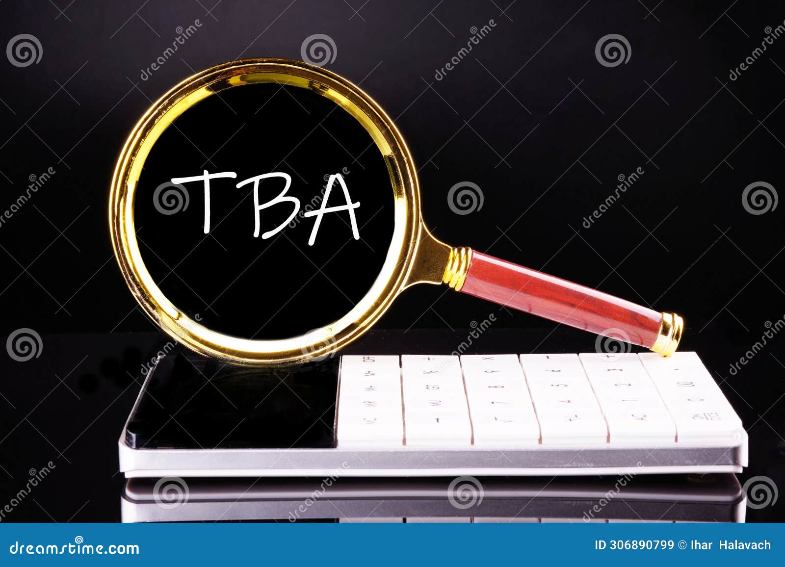 TBA a Word through a Magnifying Glass on a Calculator on a Black ...