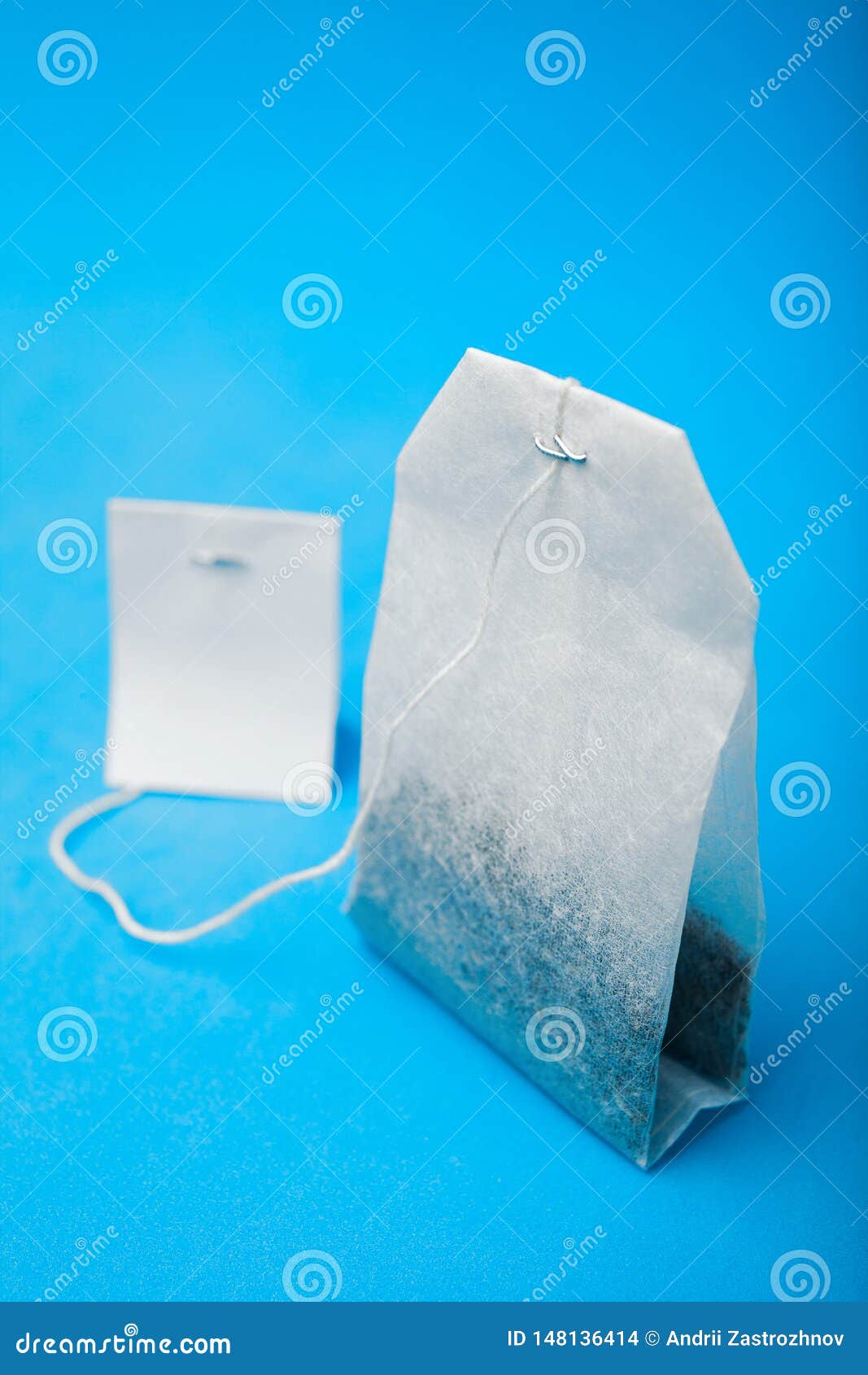 A Tea Bag on a Blue Background, Vertically Stock Photo - Image of ...
