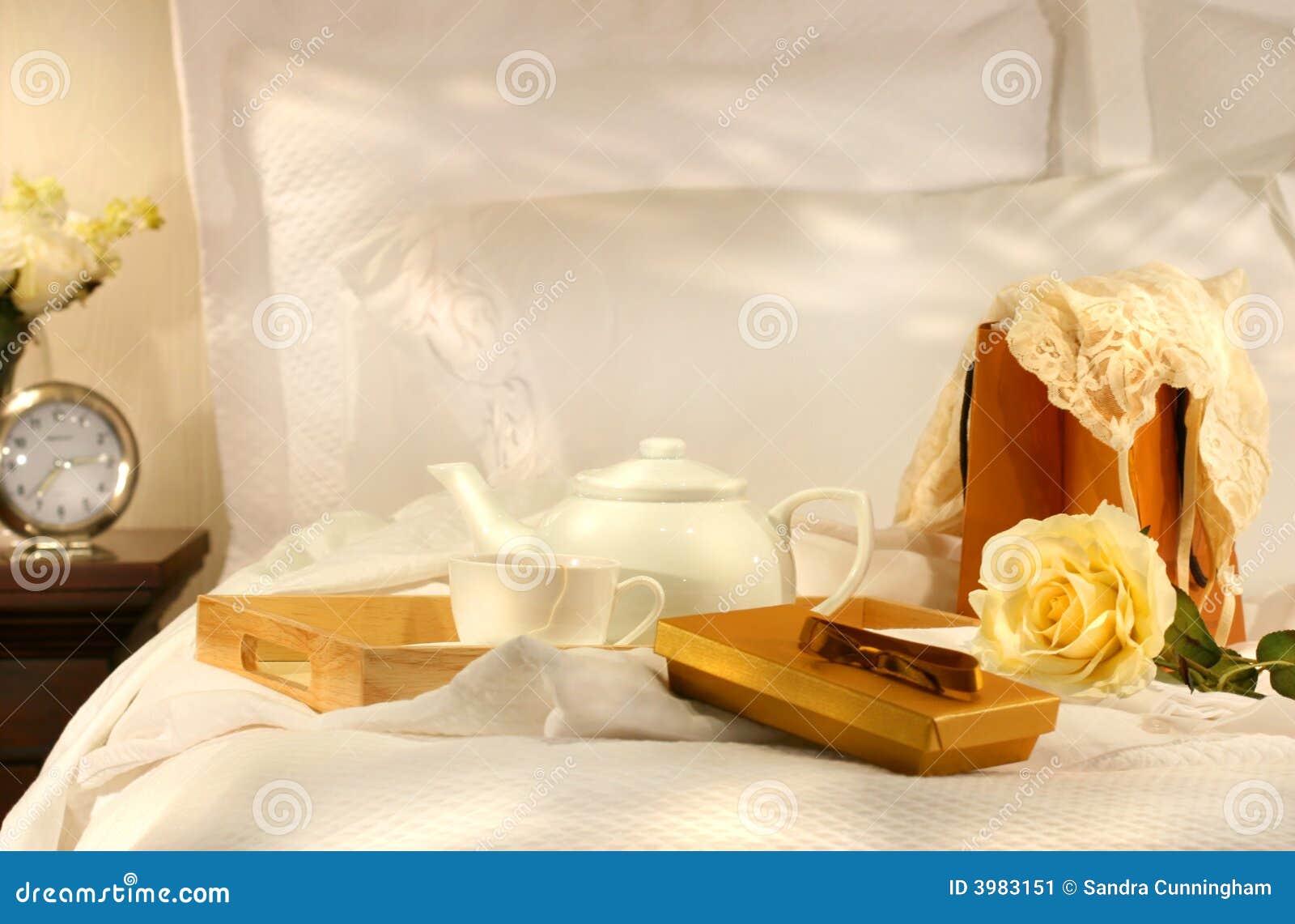 Tea in bed with chocolates stock image. Image of clock - 3983151