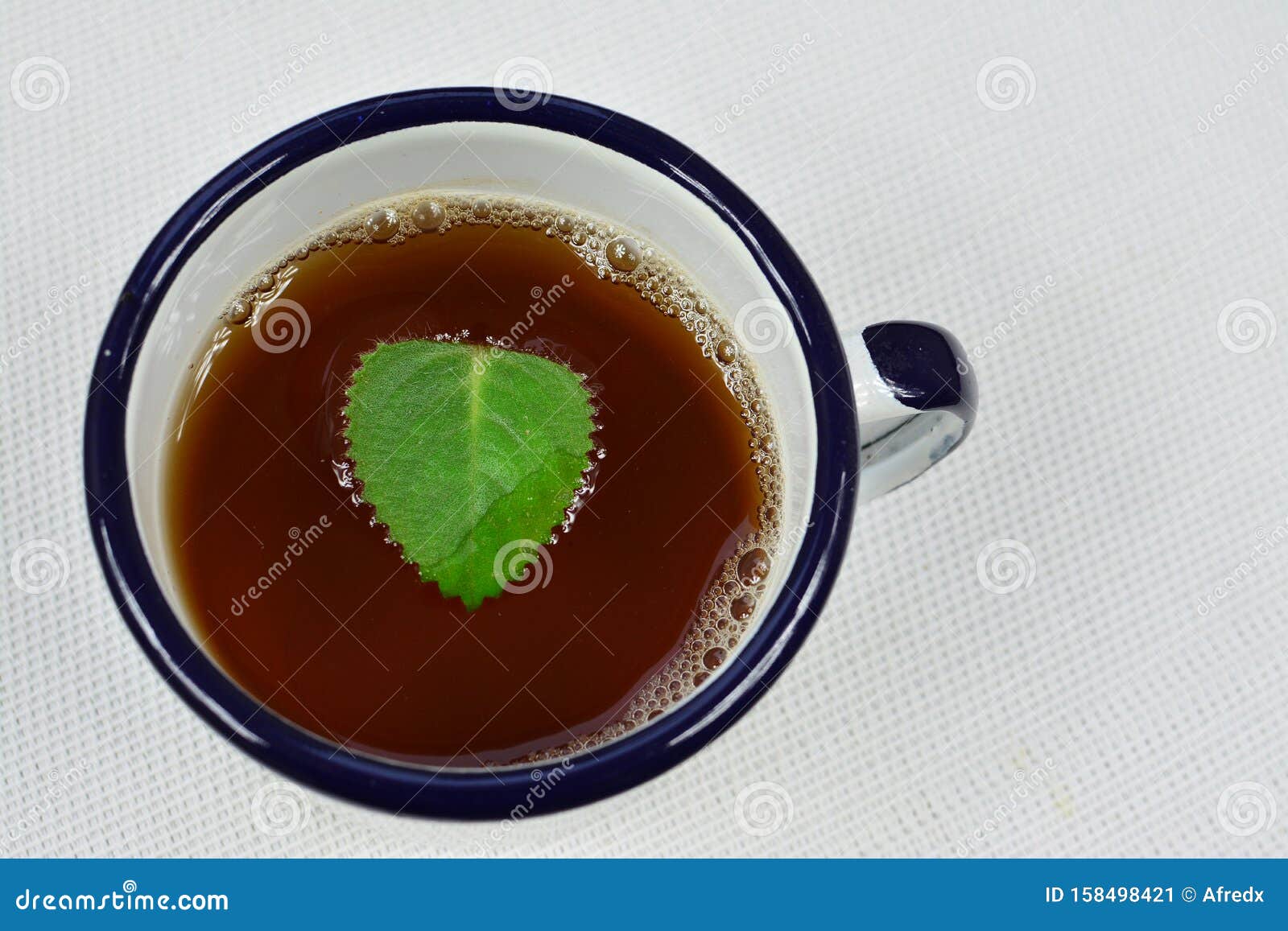 Tea cup with green leaflet stock image. Image of healthy - 158498421