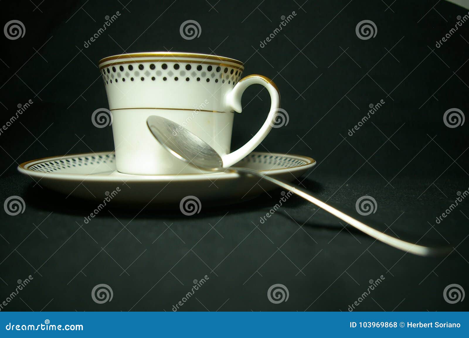On a Black Background a Antique Ceramic Teacup with a Golden Border and ...