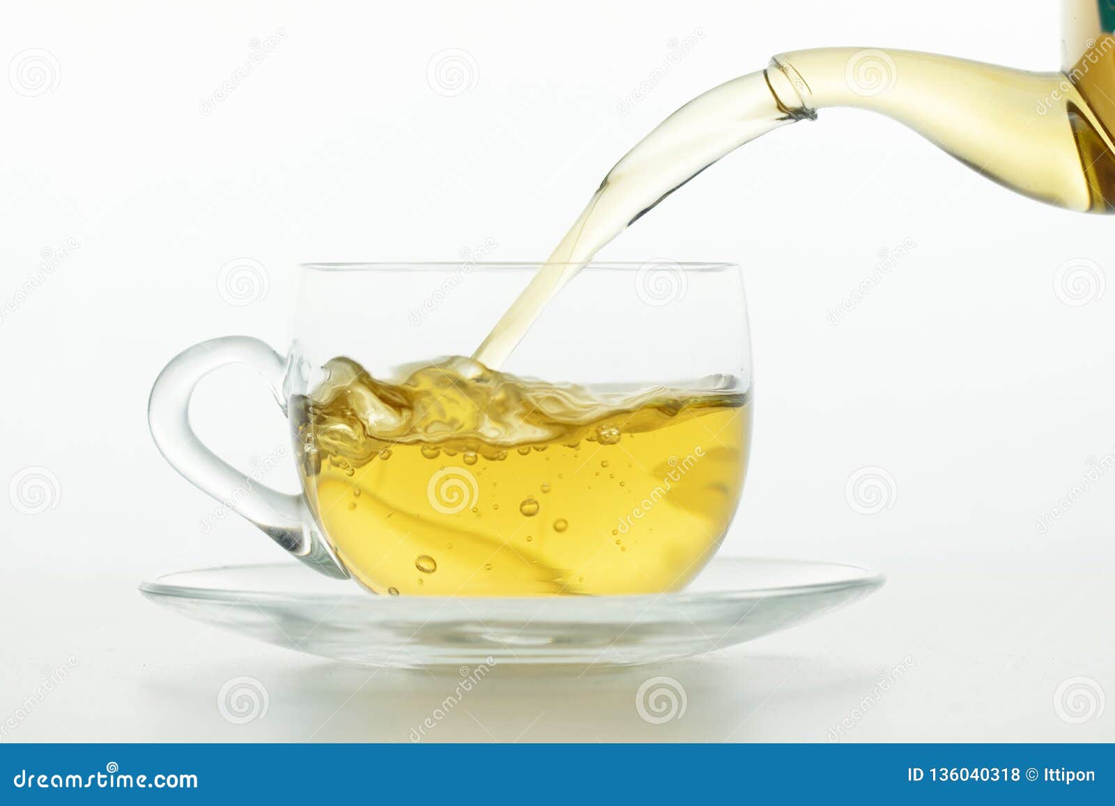 Tea pouring into tea cup stock photo. Image of brown - 136040318
