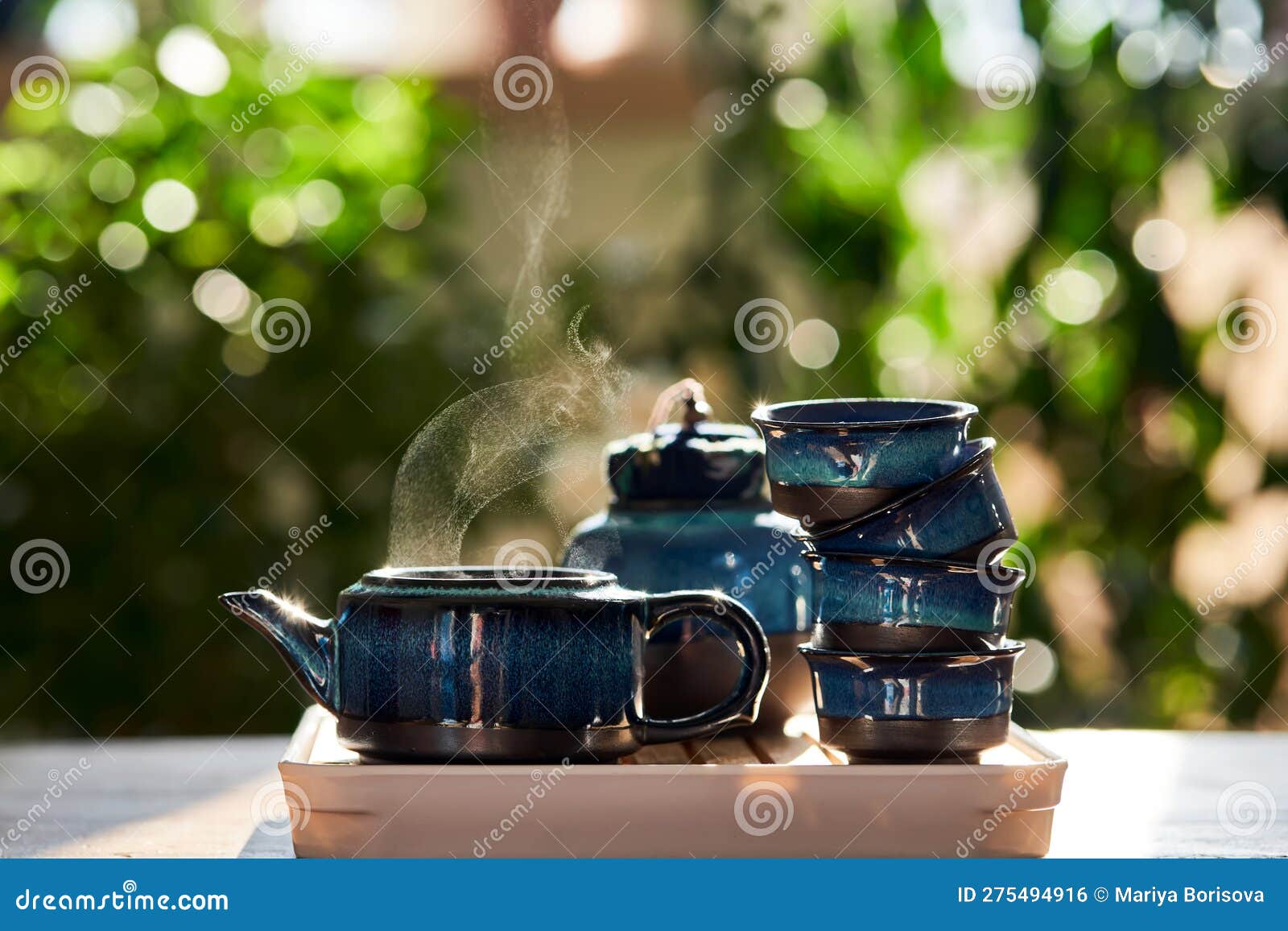 Tea Set of Deep Blue Color on a Background of Greenery. Stock Photo ...