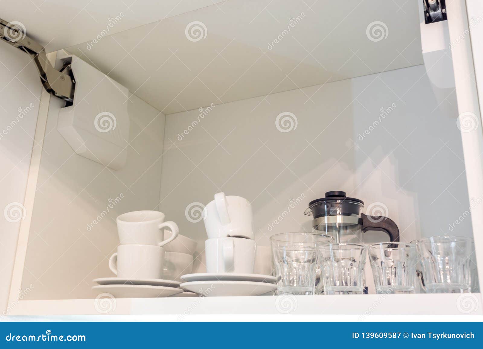 Tea Set and Kettle on the Shelf in the Kitchen Cupboard Stock Image ...