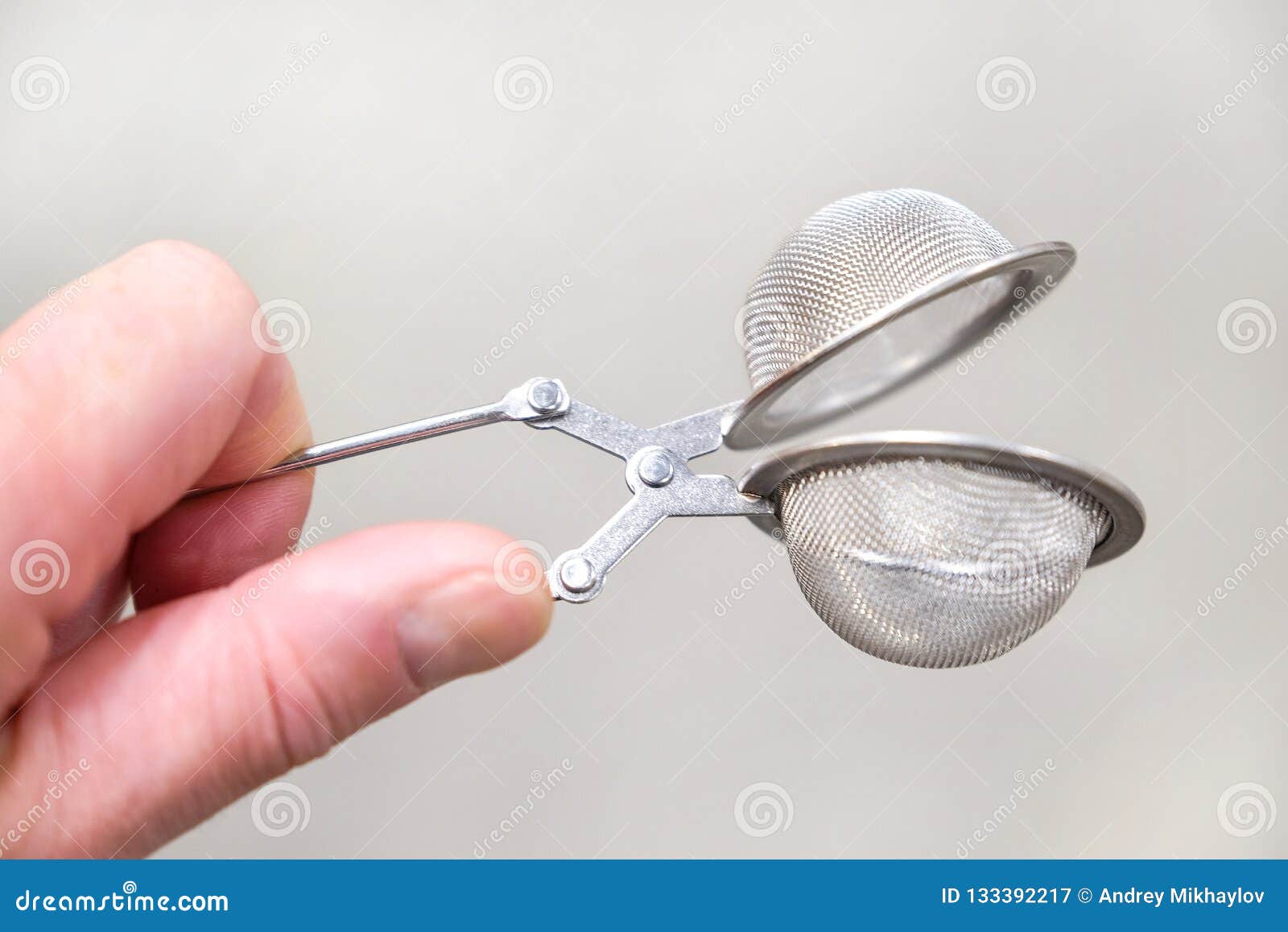 Tea Strainer in Hand Close-up on a Light Background Stock Image - Image ...