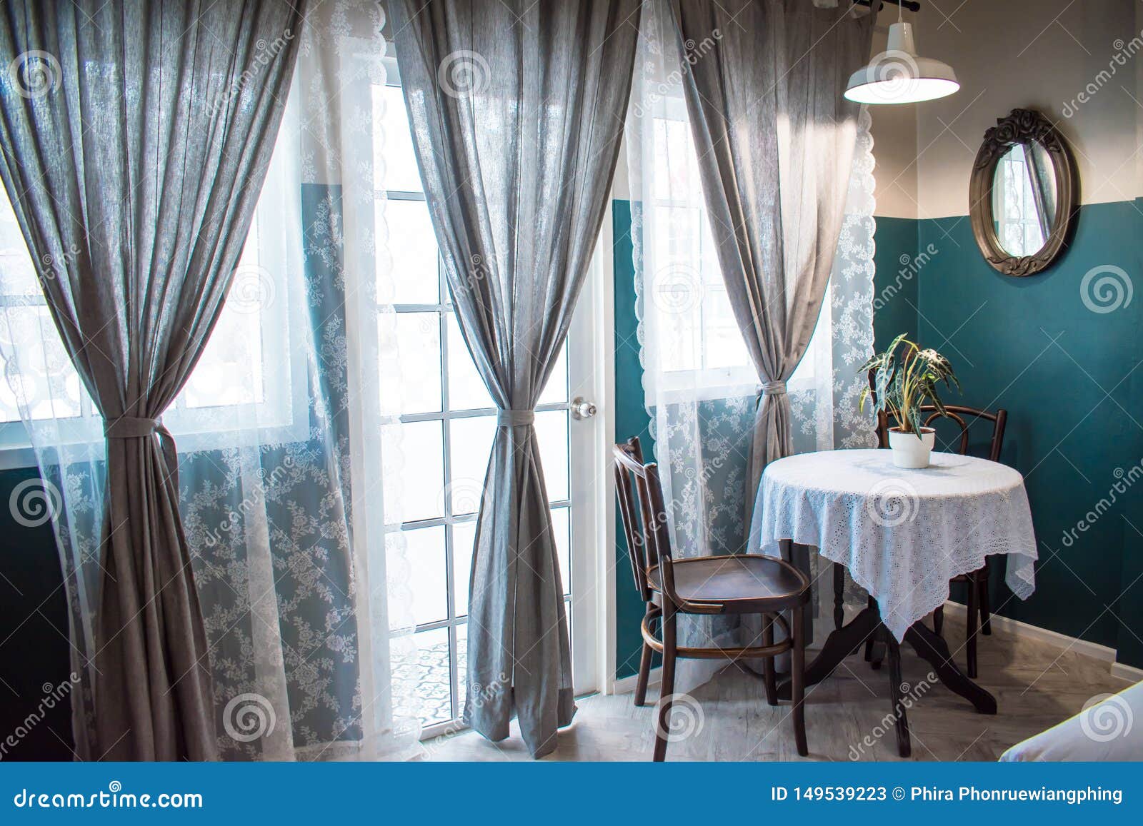 Tea Table Set with Plant Pots beside Large Windows and Large Gray ...