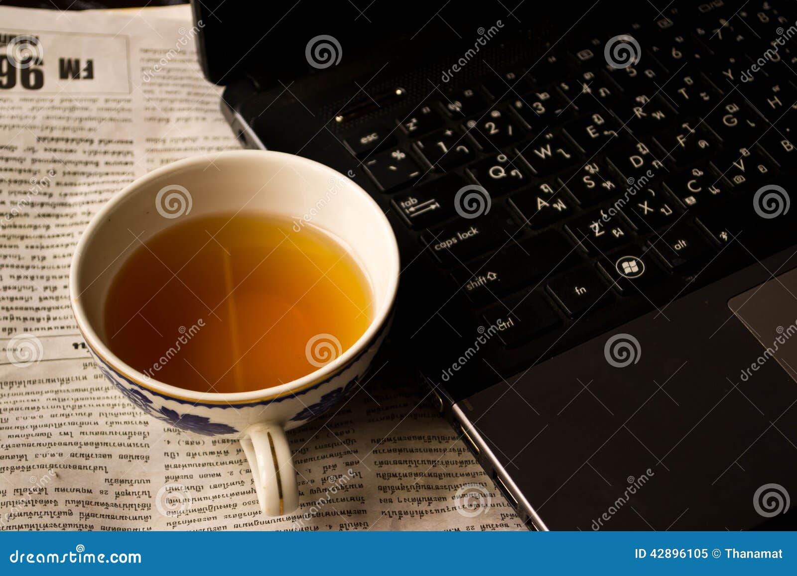 Tea in White Cup on a Table with a Computer and Newspaper Stock Image ...