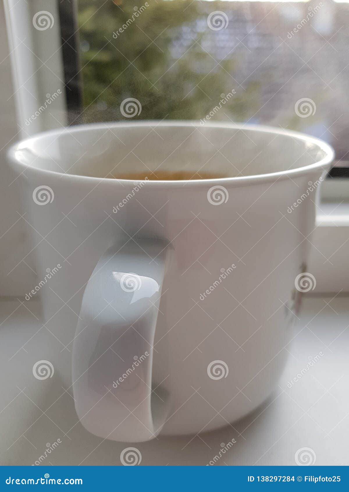 Tea in the window stock photo. Image of drinking, steam - 138297284