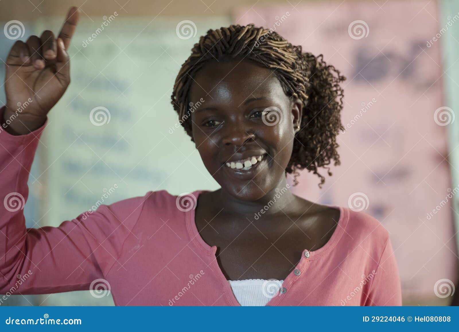 Teacher in Africa, Smiling Young Woman Shows Students How To Put Up ...