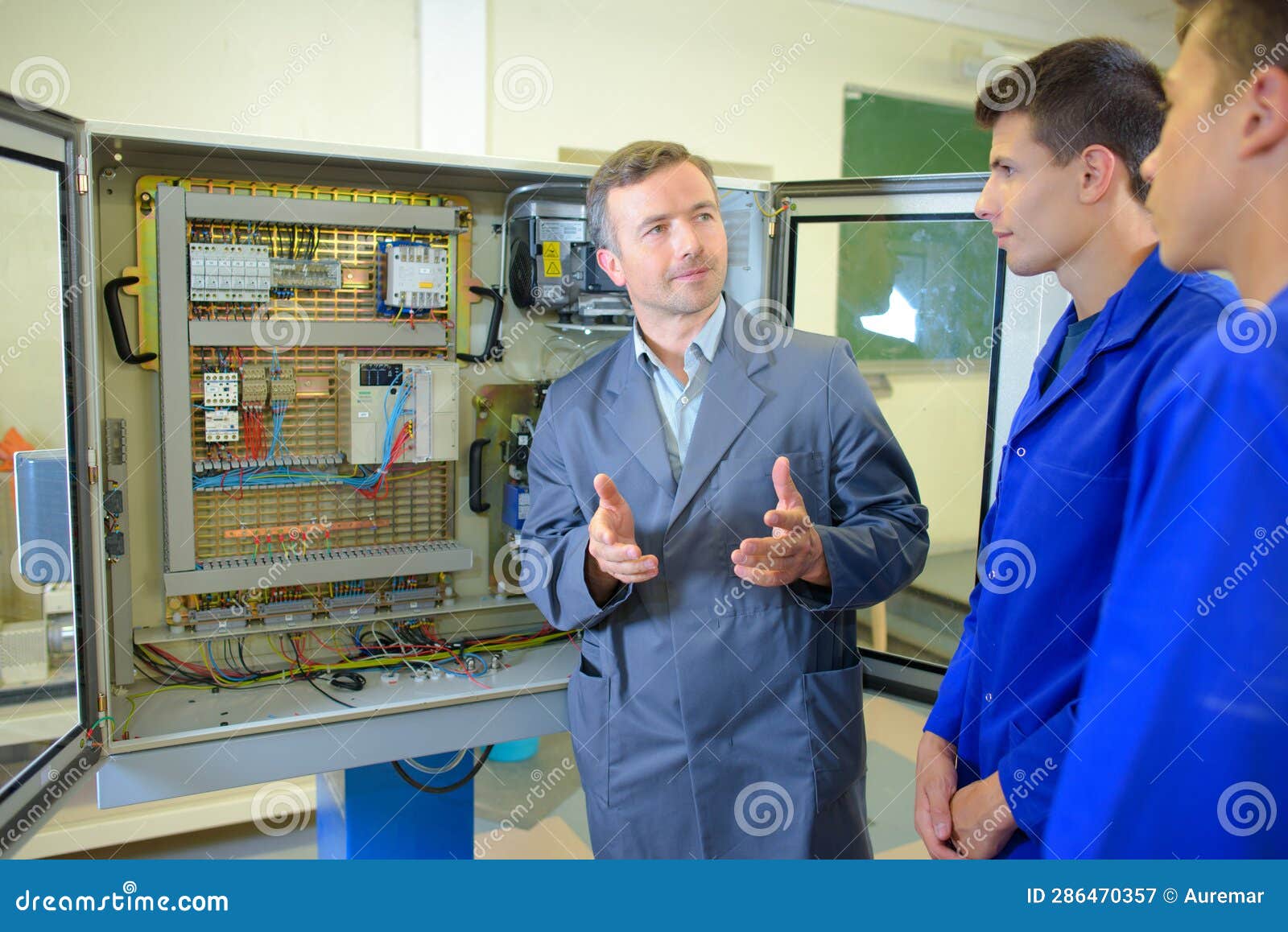 Teacher and Apprentice at Panel Board Stock Image - Image of uniform ...