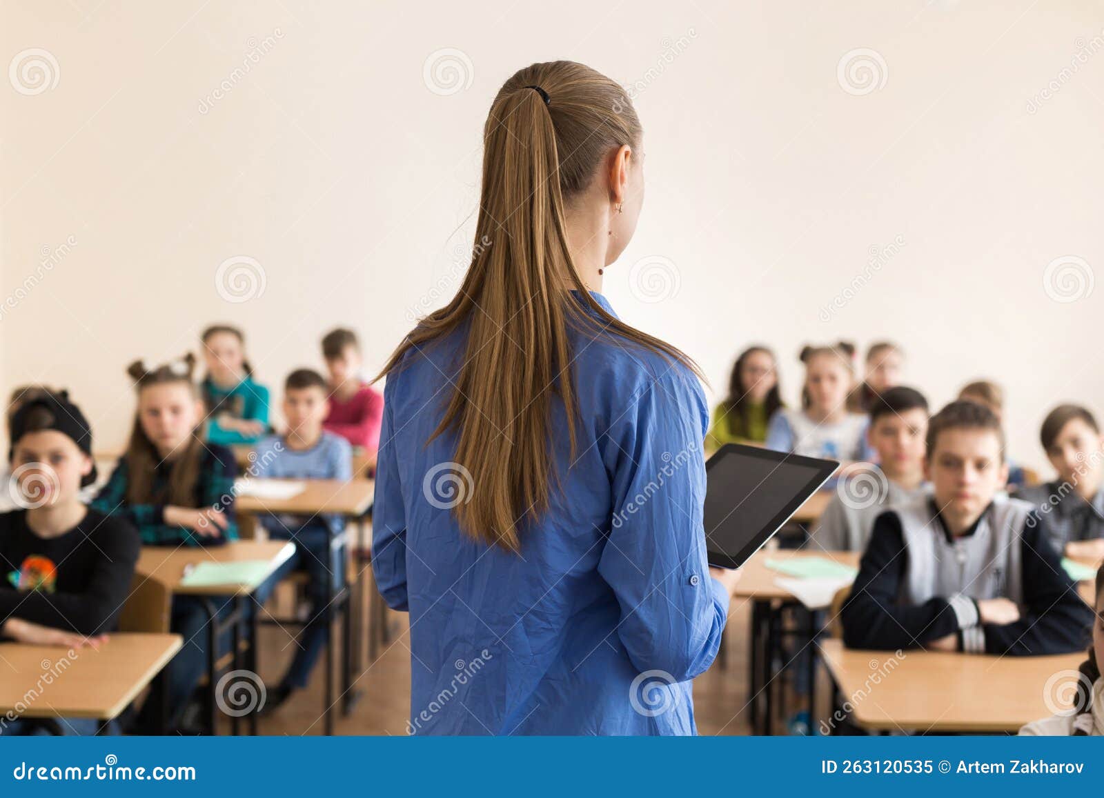 Teacher Asking Her Students a Question at the Elementary School with ...