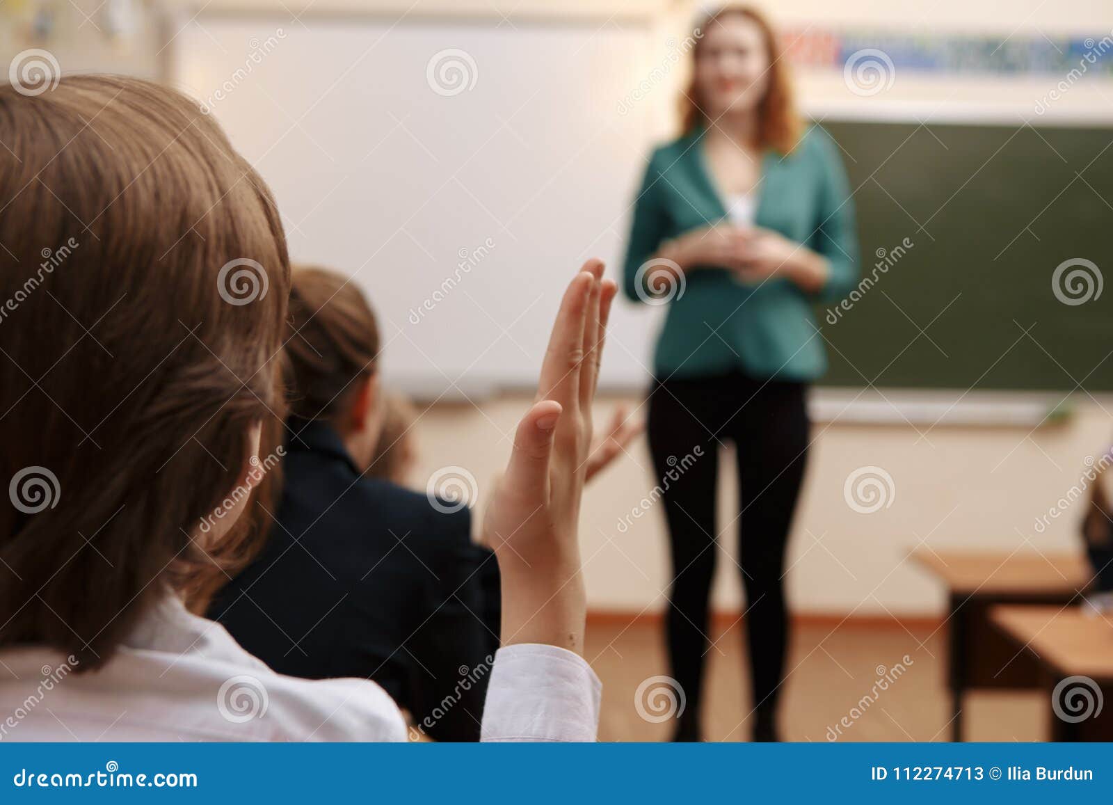 Teacher Asking Her Students a Question at the Elementary School Stock ...