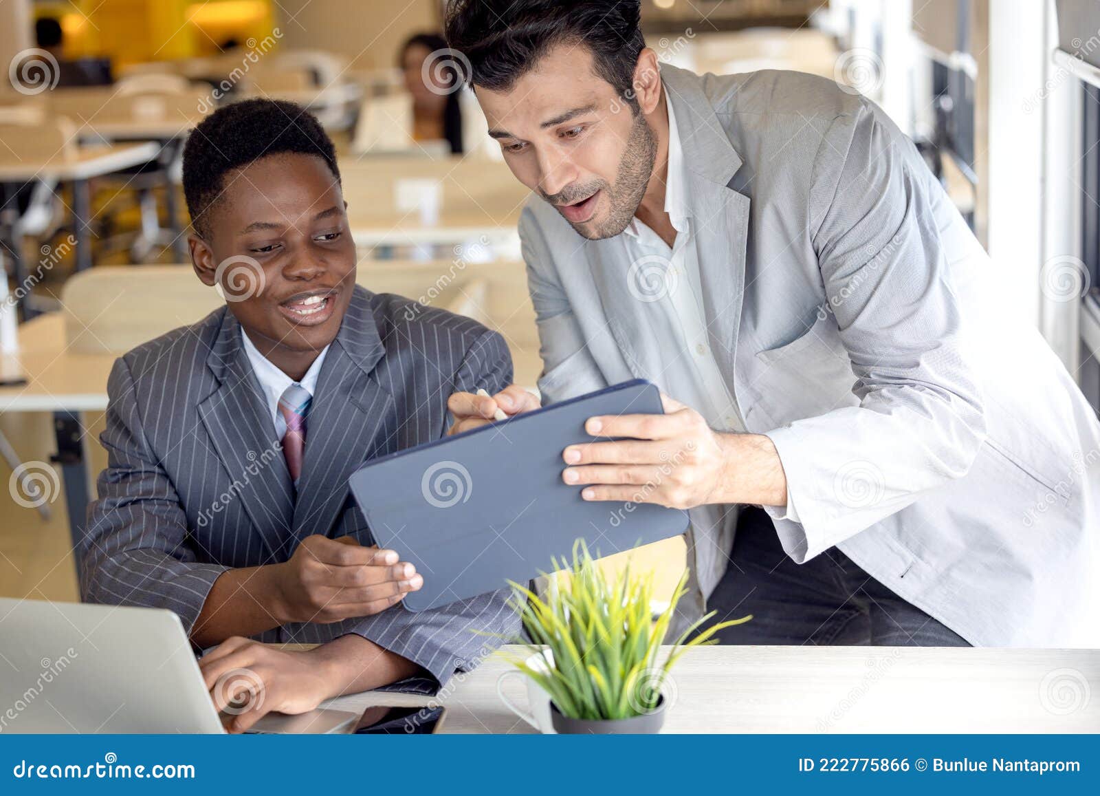 Teacher Assisting Black Man Working on Tablet at School Stock Photo ...