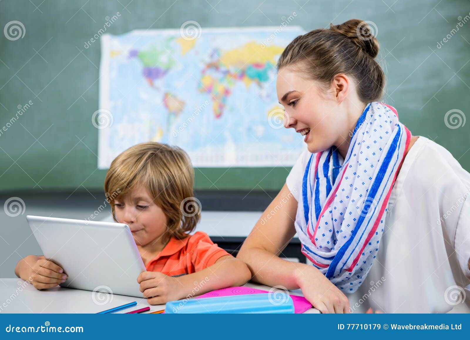 Teacher Assisting Boy Using Digital Tablet Stock Image - Image of ...
