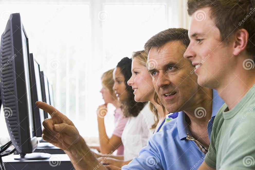 Teacher Assisting College Student in Computer Lab Stock Image - Image ...