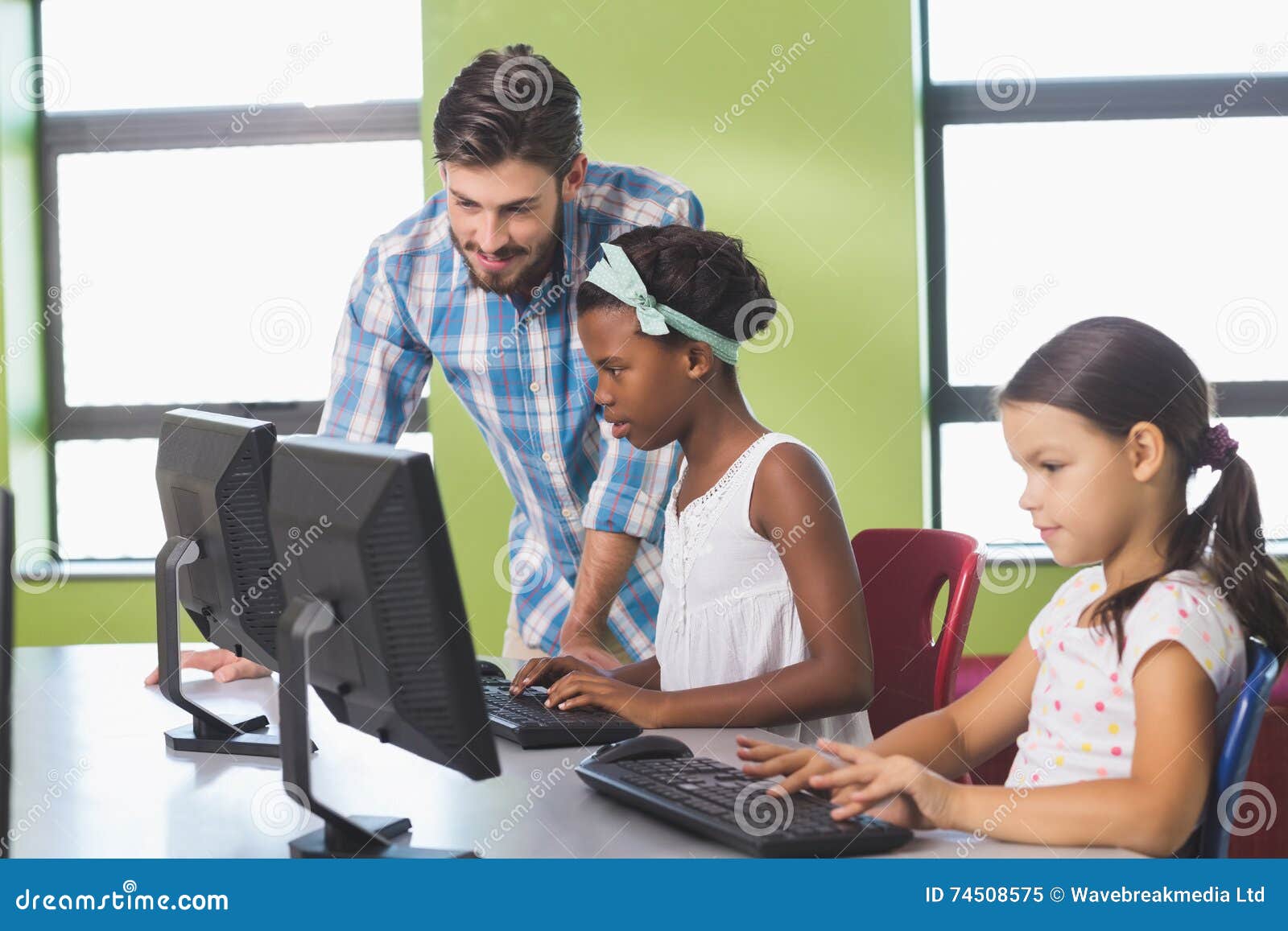 Teacher Assisting Schoolgirls in Learning Computer Stock Image - Image ...