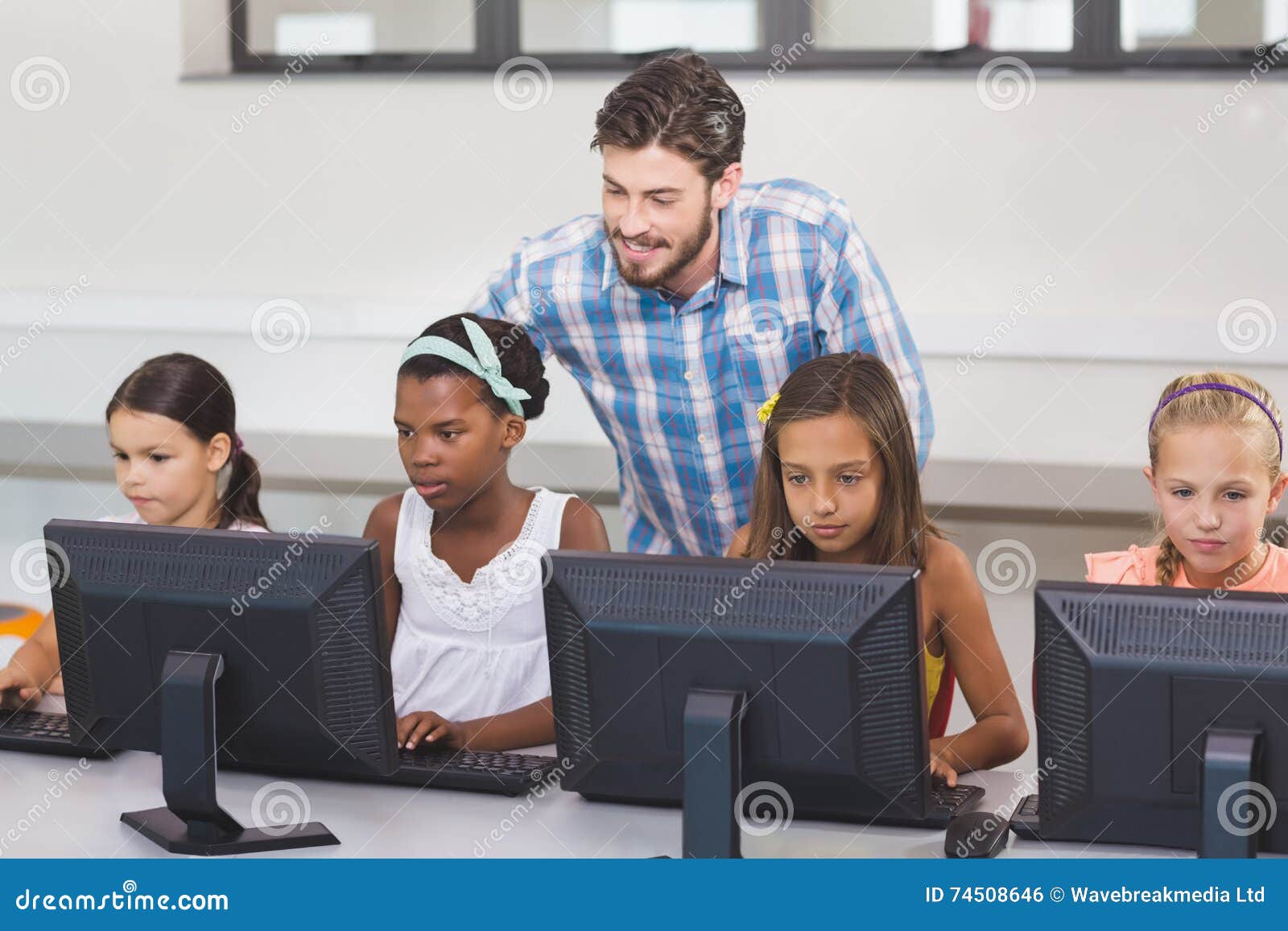 Teacher Assisting Schoolgirls in Learning Computer Stock Photo - Image ...