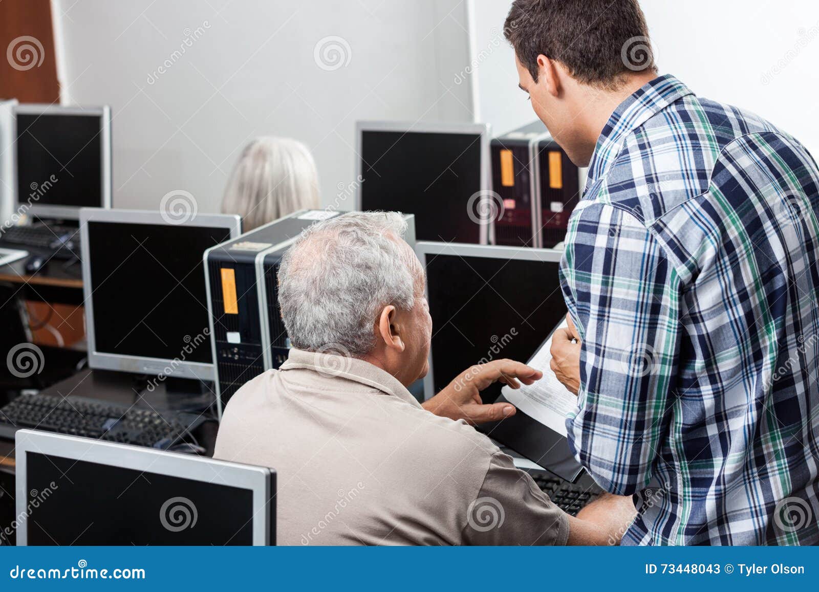 Teacher Assisting Senior Man in Using Computer at Classroom Stock Image ...