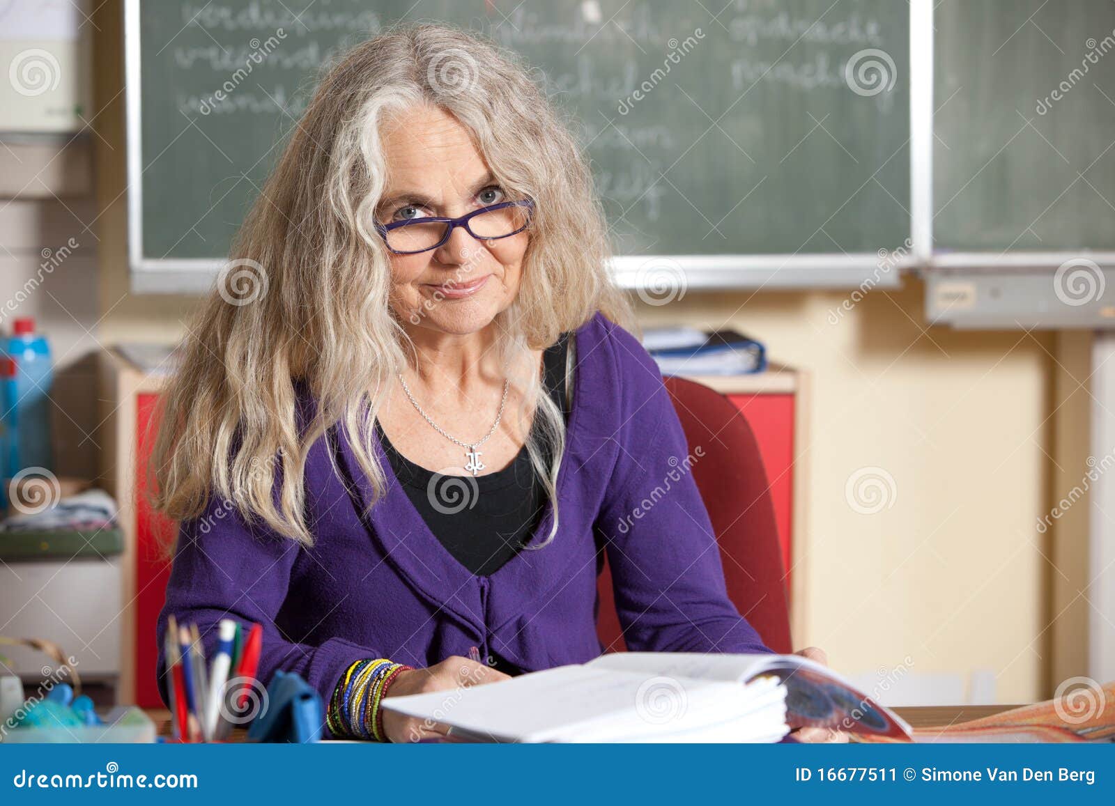 Teacher behind her desk stock image. Image of pretty - 16677511