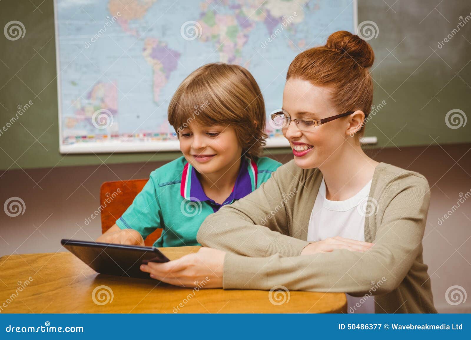 Teacher and Boy Using Digital Tablet in Classroom Stock Image - Image ...