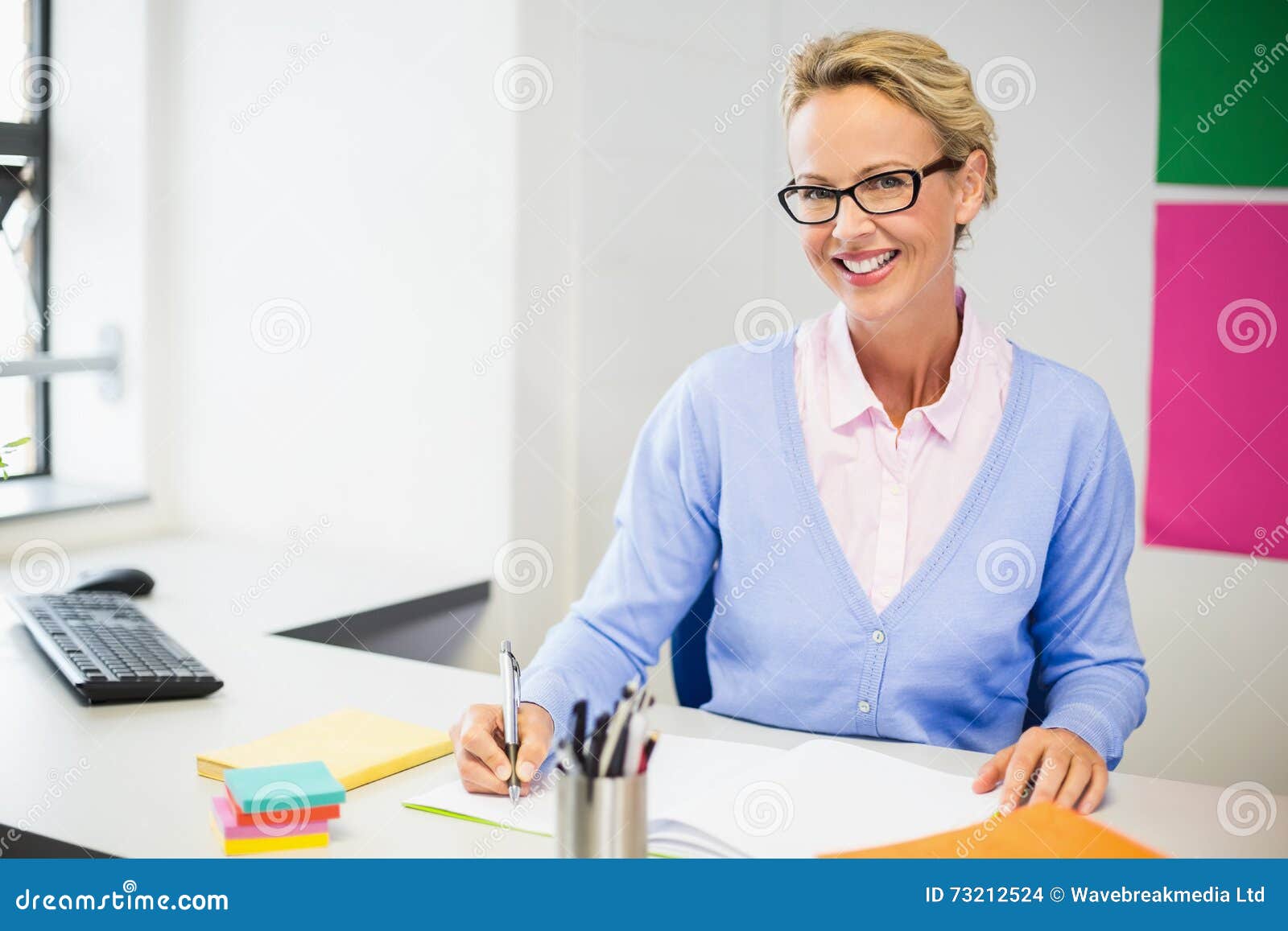 Teacher Checking Book in Classroom Stock Photo - Image of casual ...