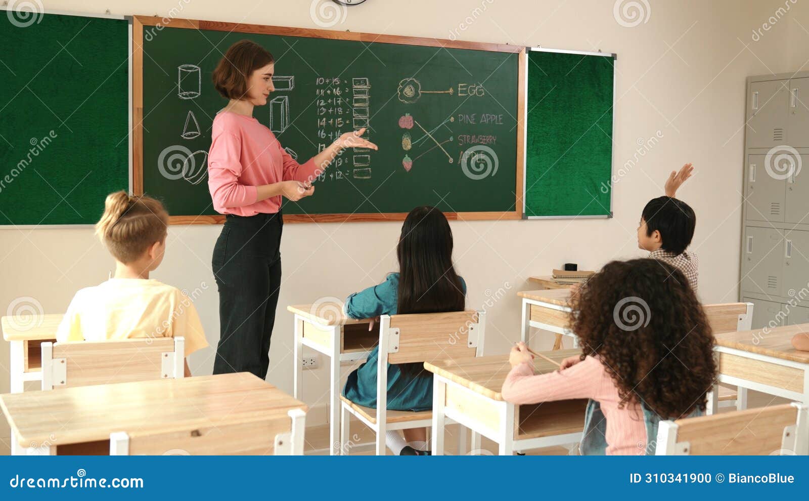 Teacher Checking Cute Student Homework while Explaining Idea at Class ...