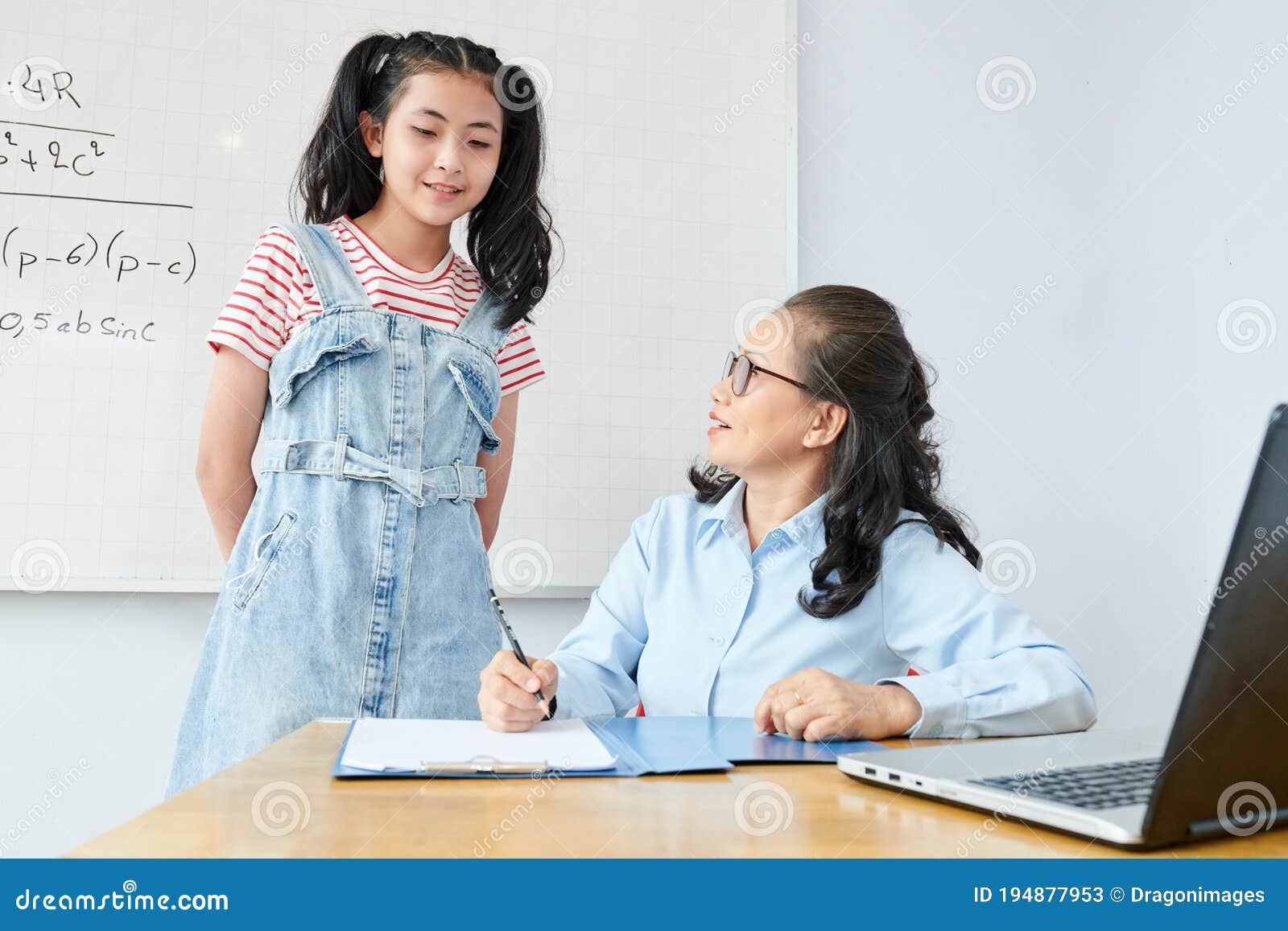 Teacher checking math test stock image. Image of student - 194877953