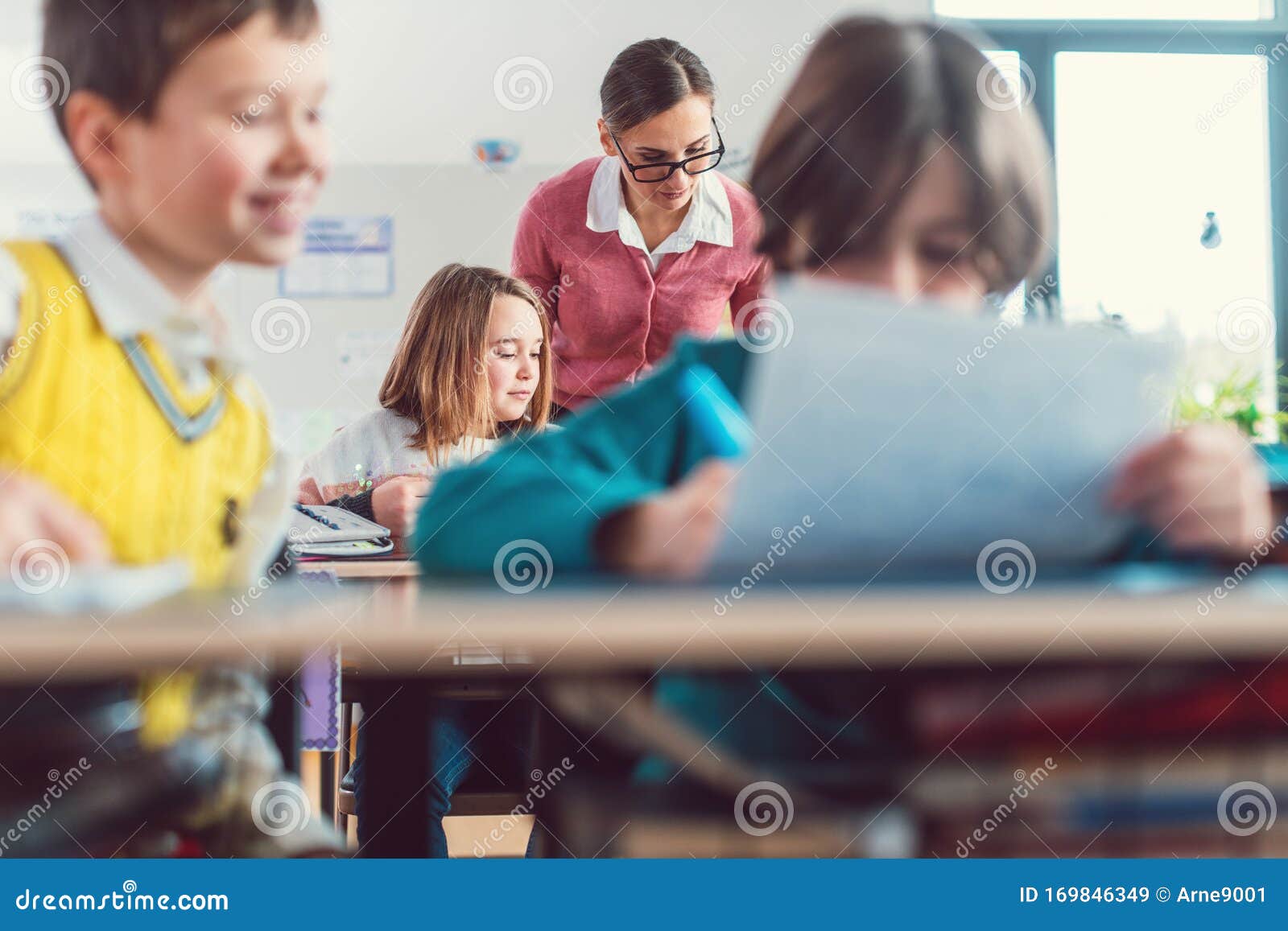 Teacher Checking Results of a Written Test in Class Talking To the ...