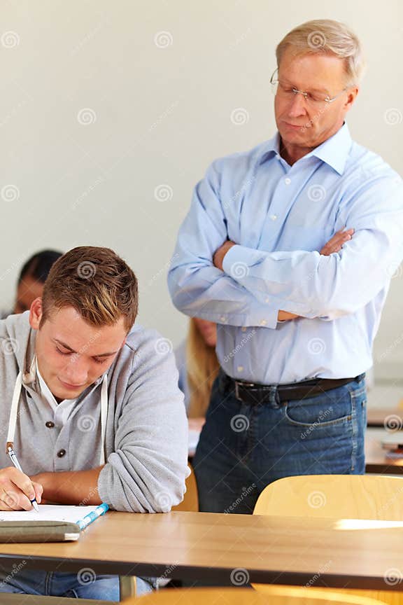 Teacher Checking Students at Test Stock Photo - Image of seminar ...