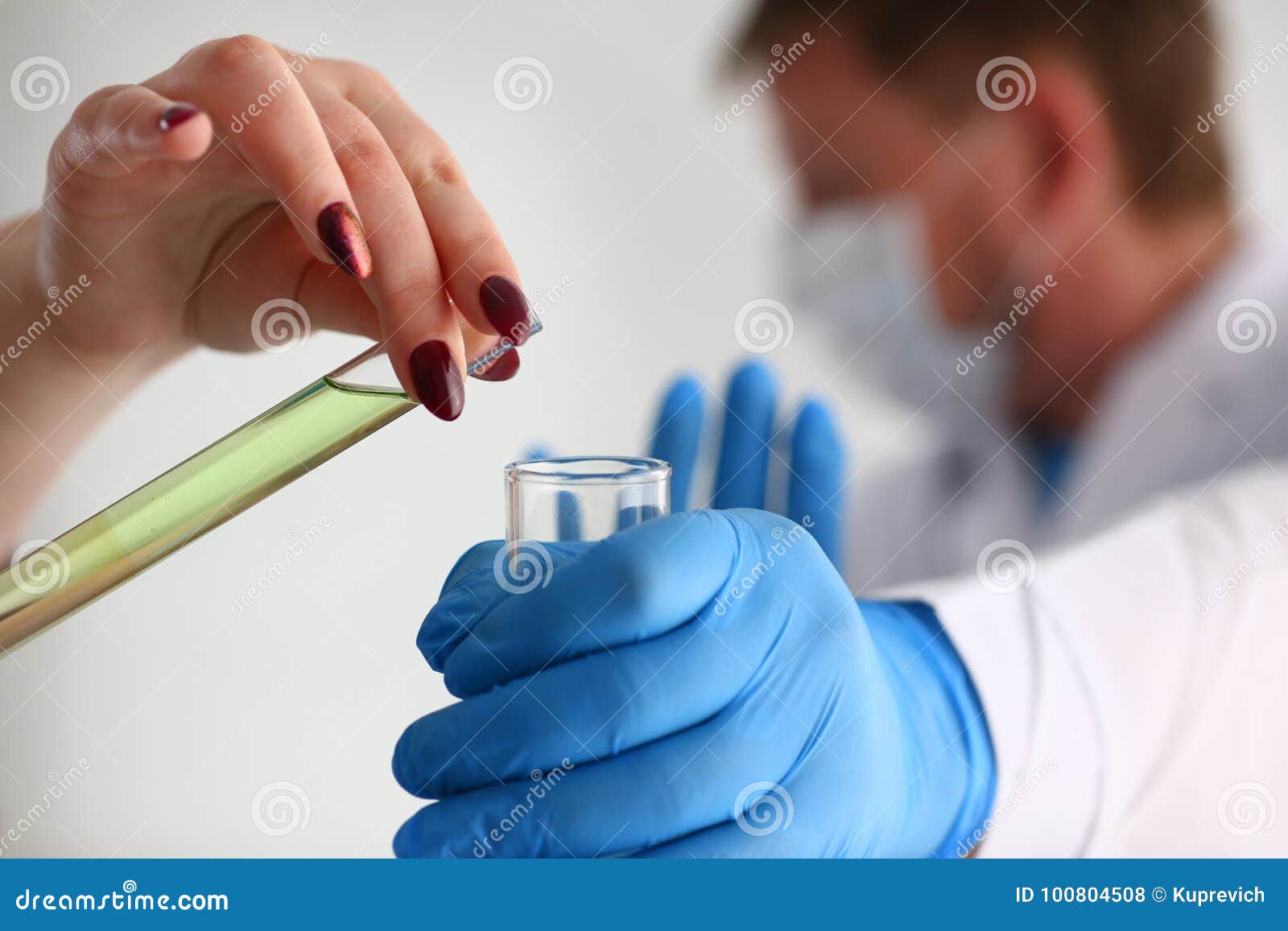 A Male Chemist Holds Test Tube of Glass in His Hand Overflows a Liquid ...