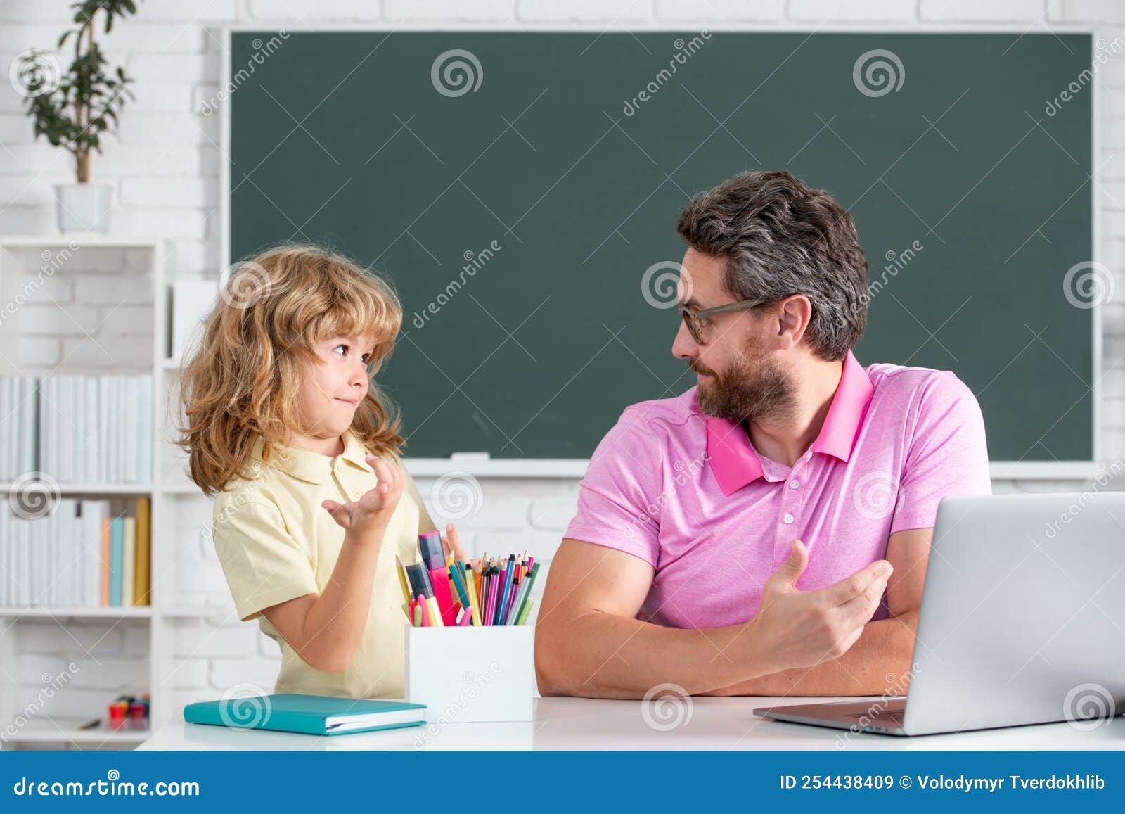 Teacher and Child from Elementary School Learning at Classroom. Stock ...