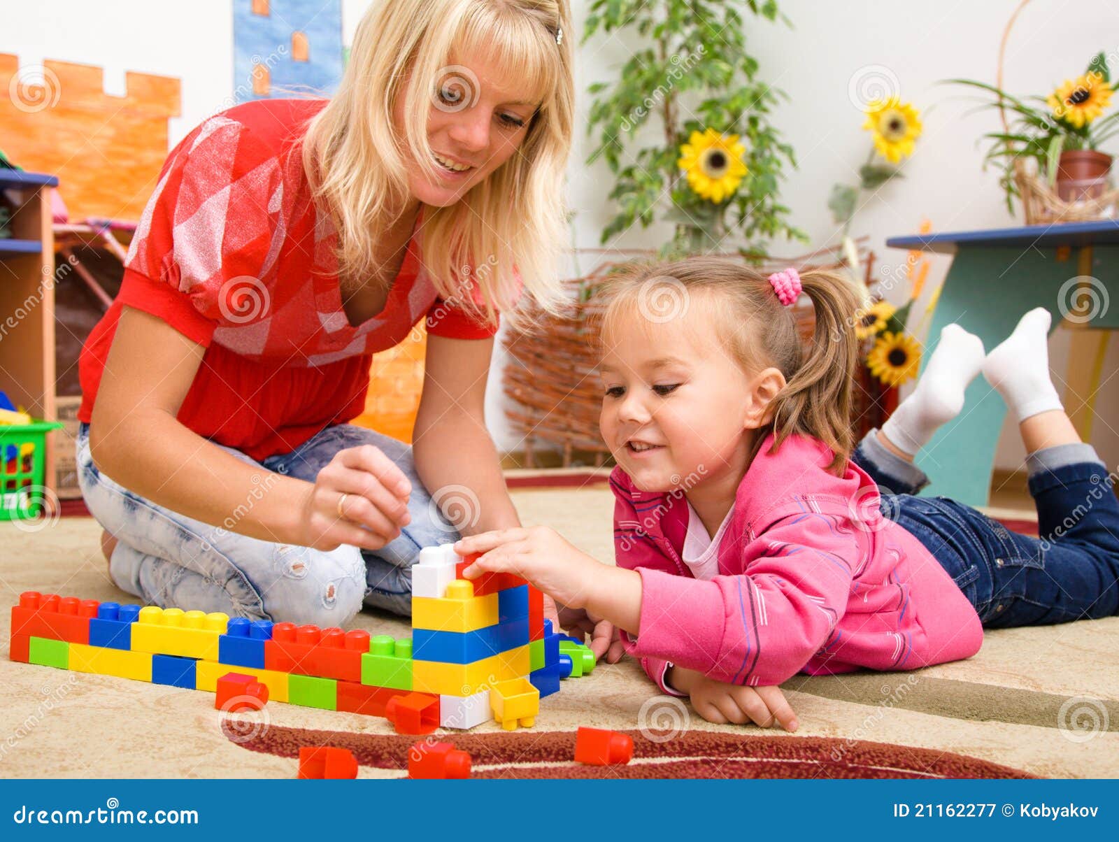 Teacher And Child Are Playing With Bricks Royalty Free Stock ...