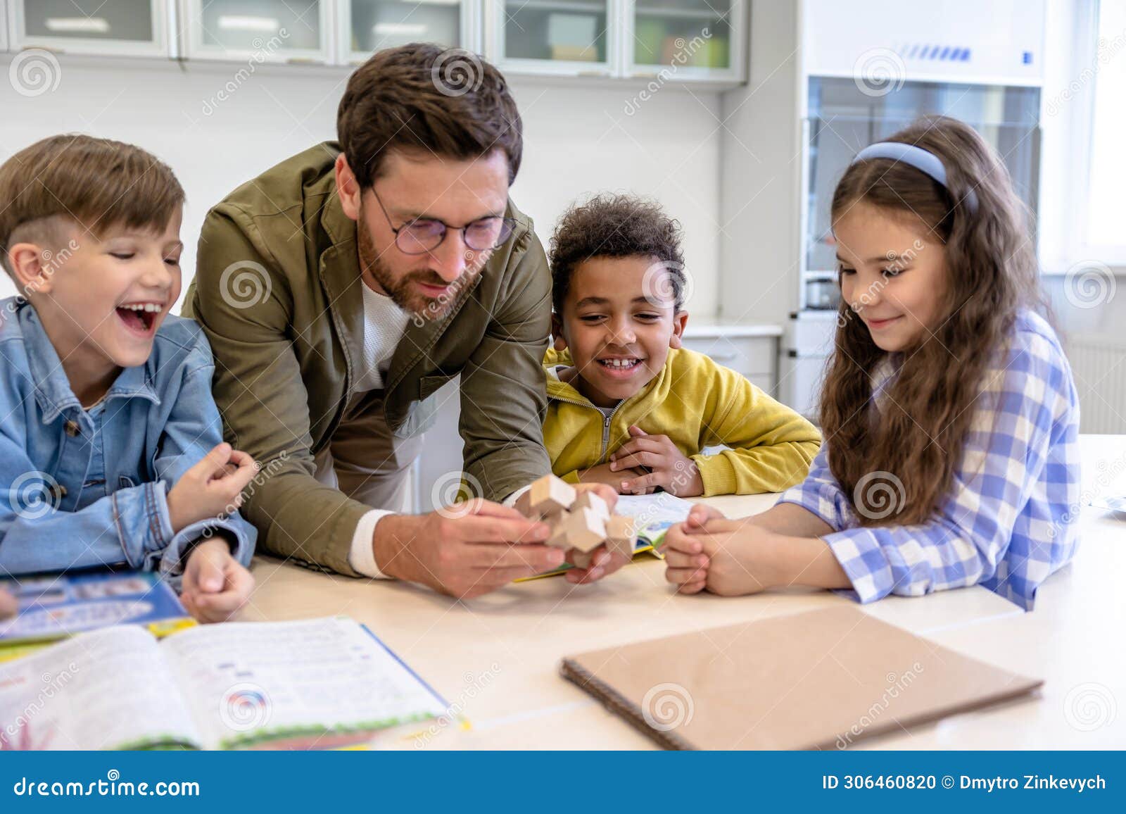 Teacher and Children in a Classroom, Exploring a New Topic in Chemistry ...