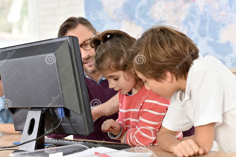 Teacher with Children Working on Computer Stock Image - Image of ...